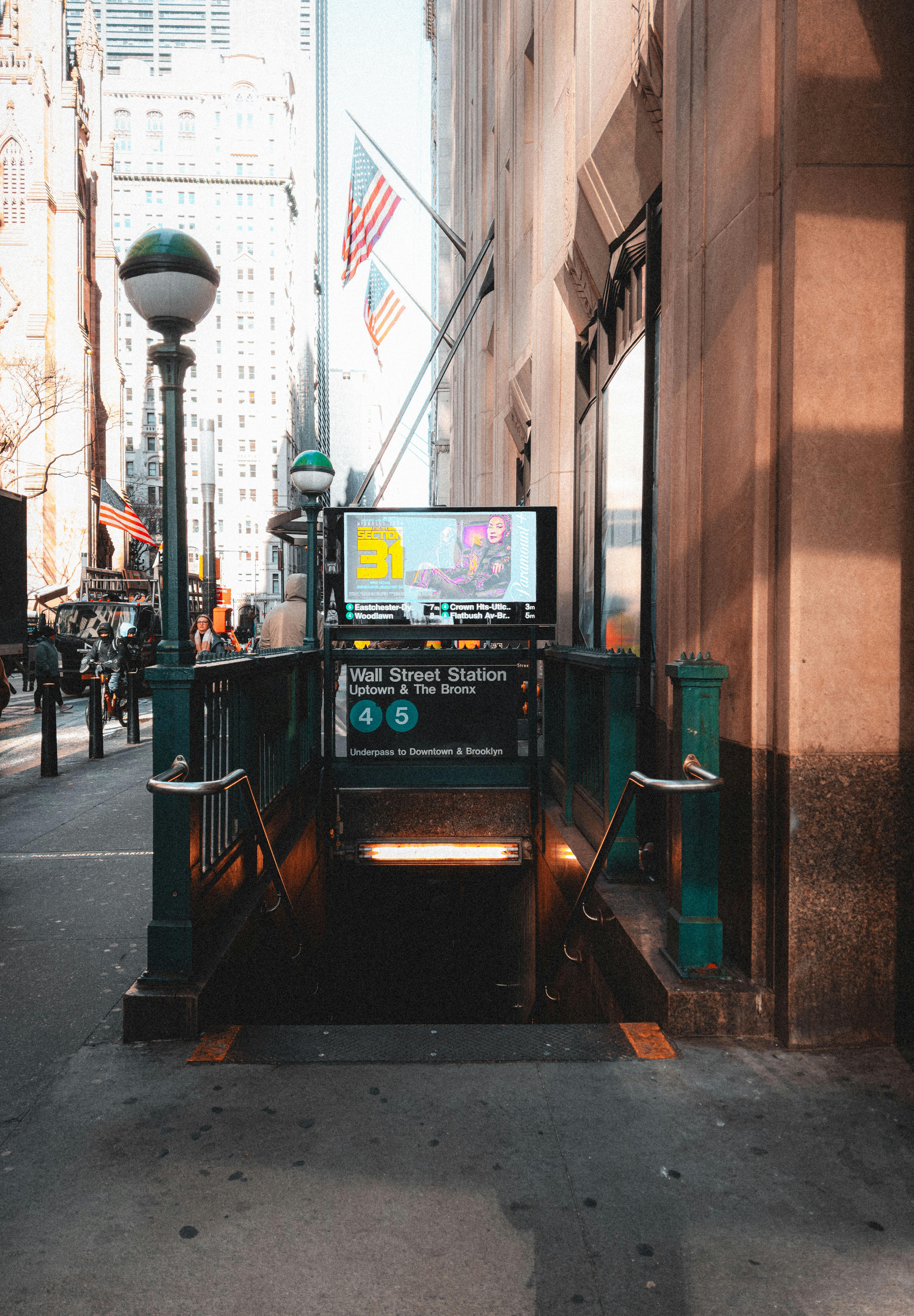 Wall Street Subway Entrance with Buildings and Flags · Free Stock Photo
