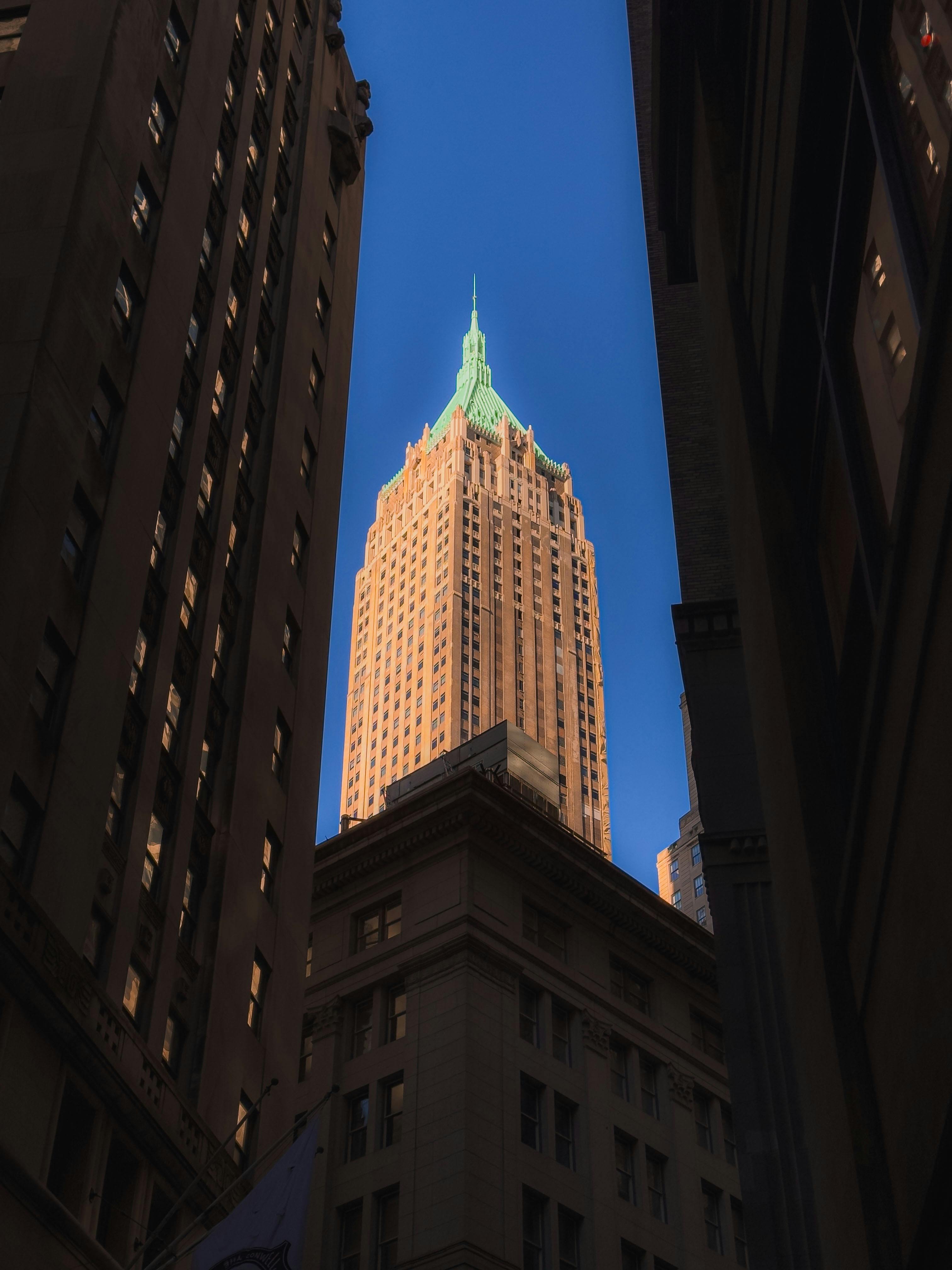 Iconic Skyscraper Framed by Shadows in Urban Street · Free Stock Photo