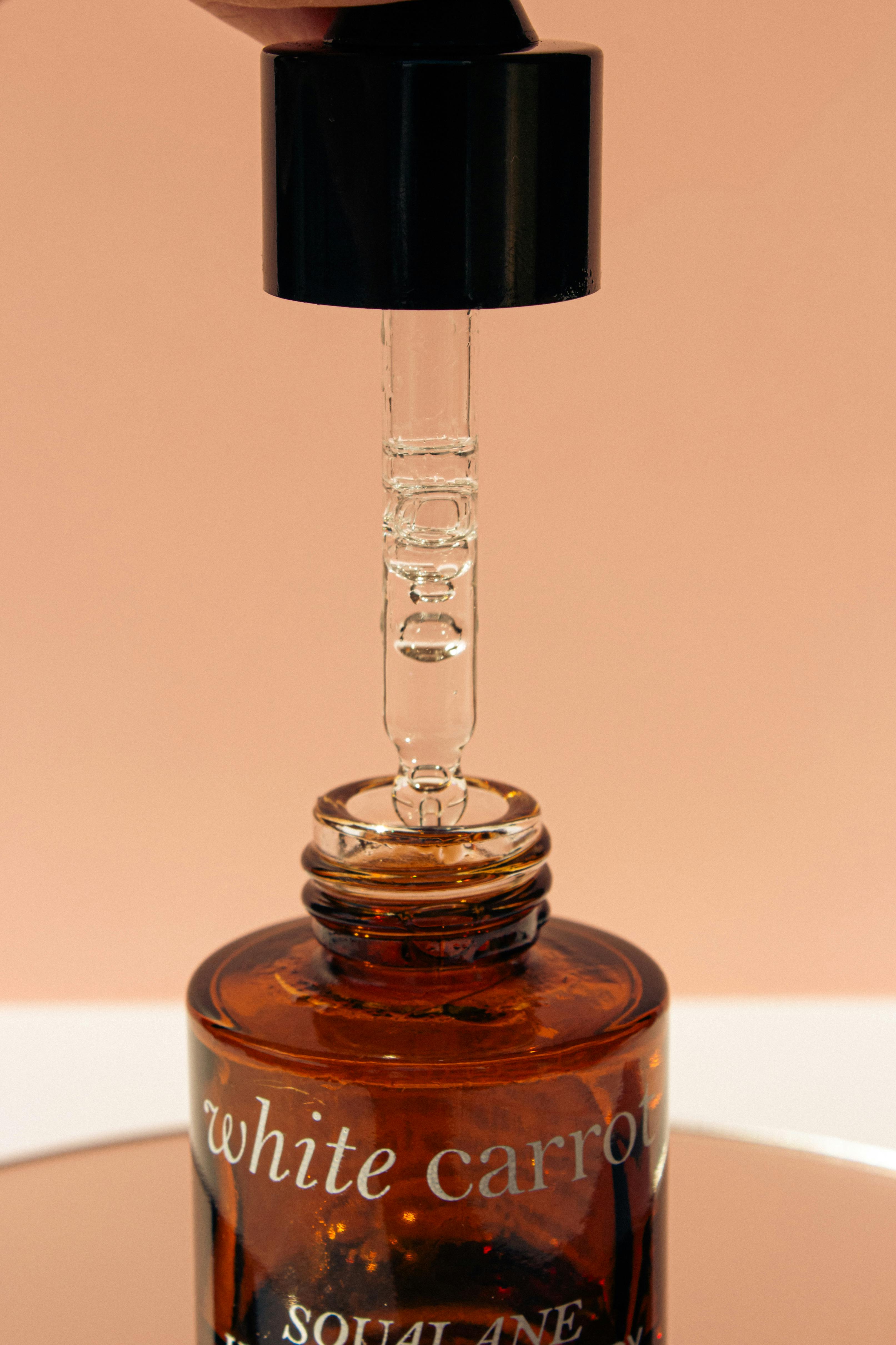 Luxury Serum Bottle with Dropper on Pastel Background · Free Stock Photo