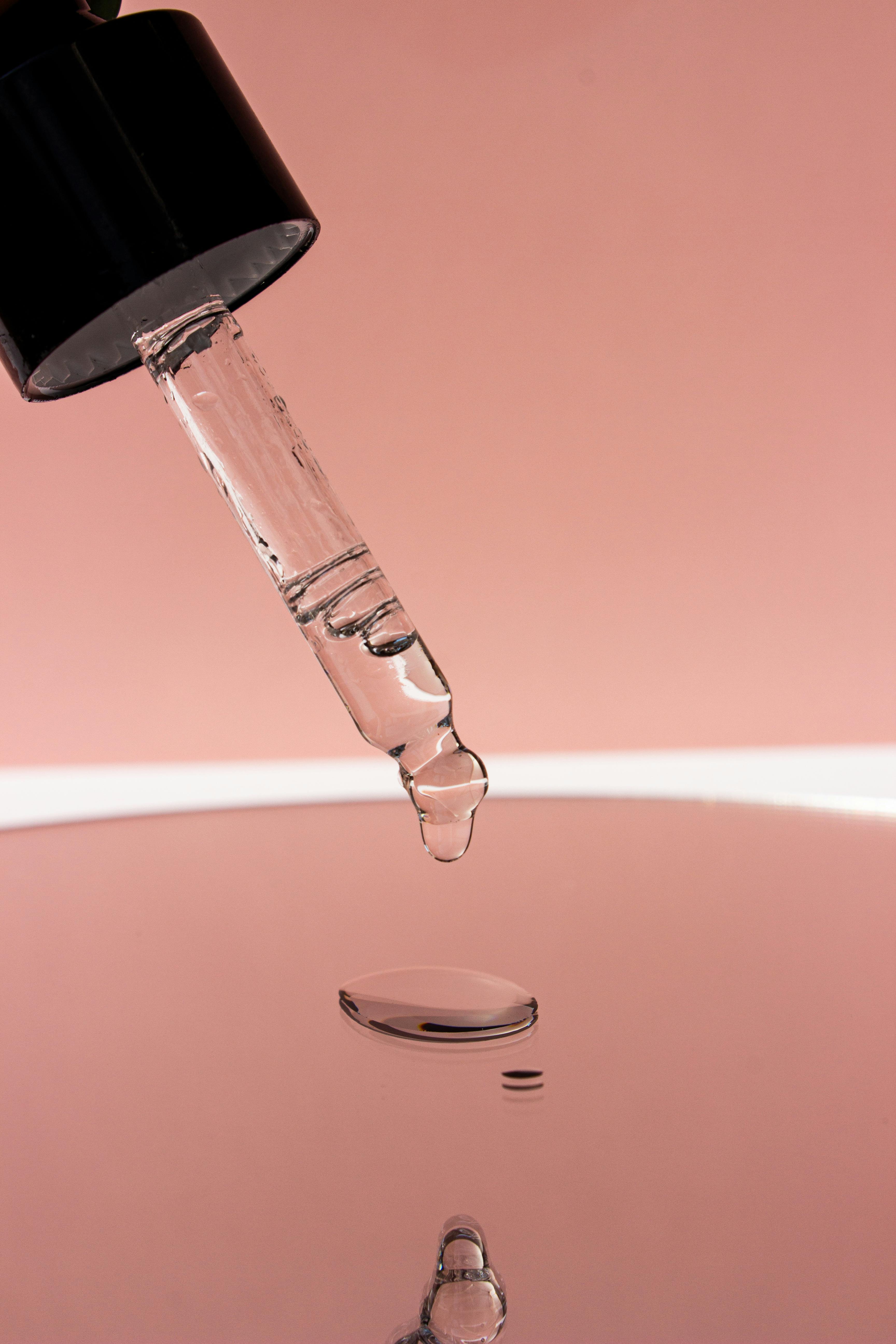 Close-up of Liquid Dropper with Reflection · Free Stock Photo