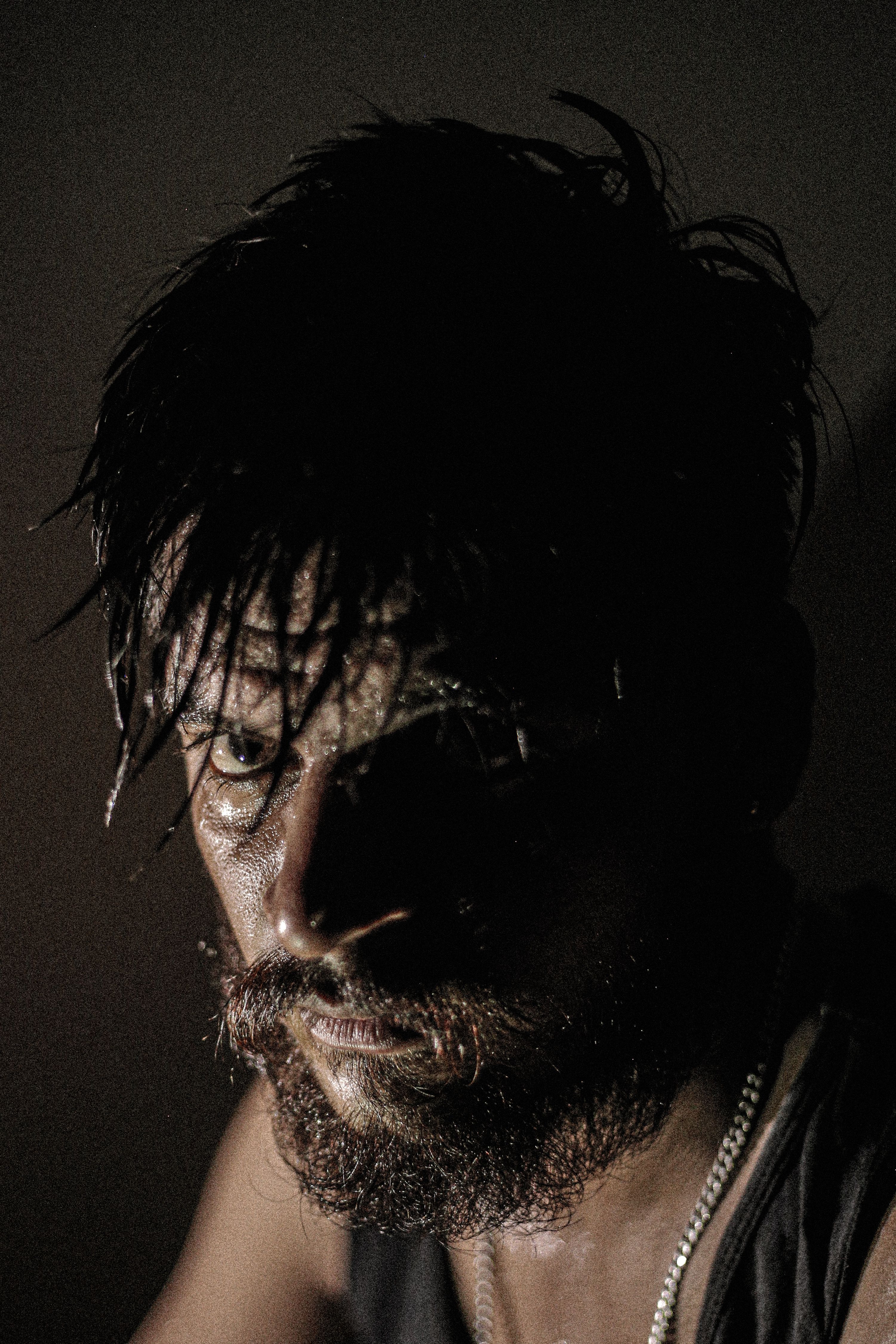 Moody Portrait of Man with Wet Hair in Dark Lighting · Free Stock Photo
