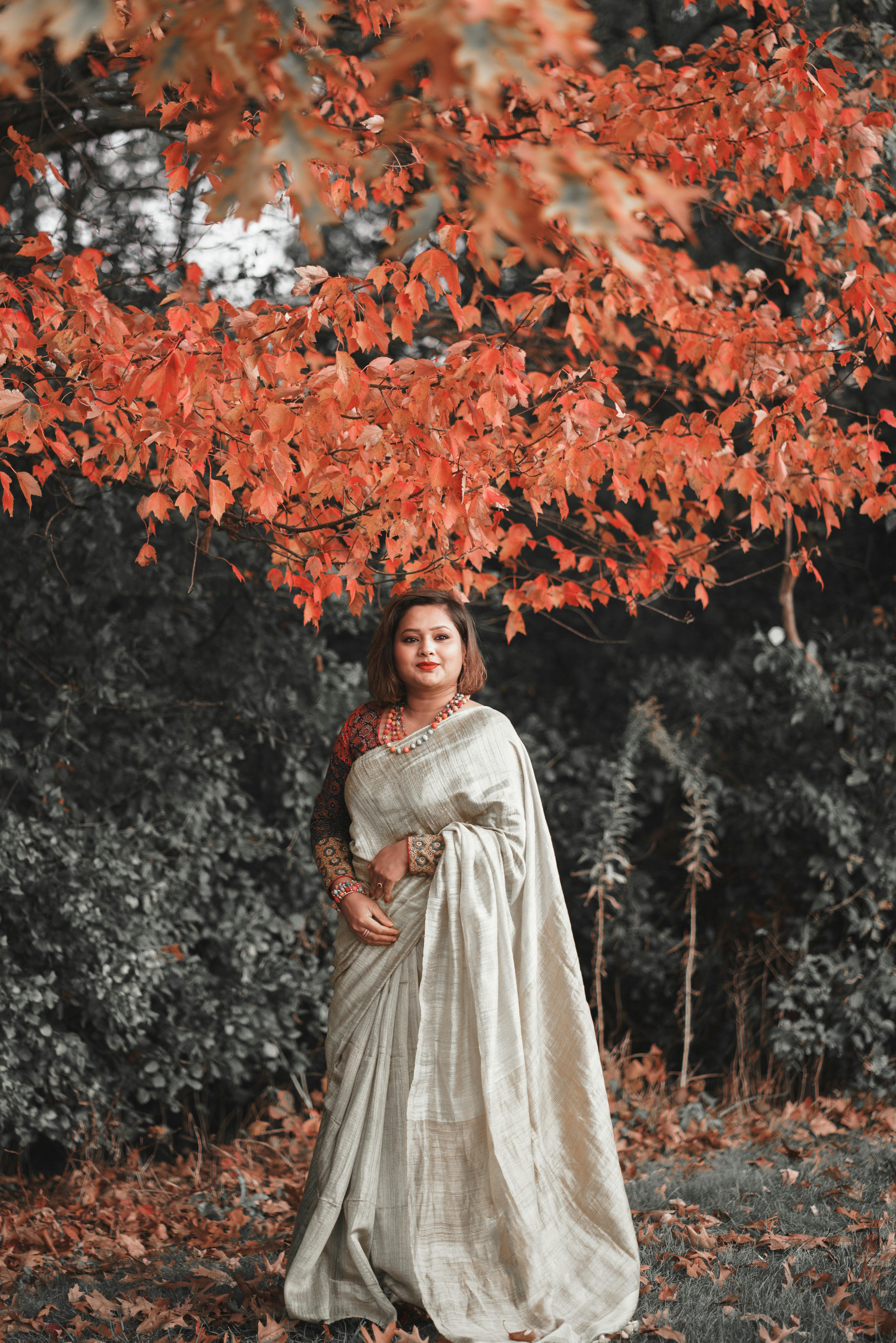 Elegant Woman in Saree Under Vibrant Fall Foliage · Free Stock Photo