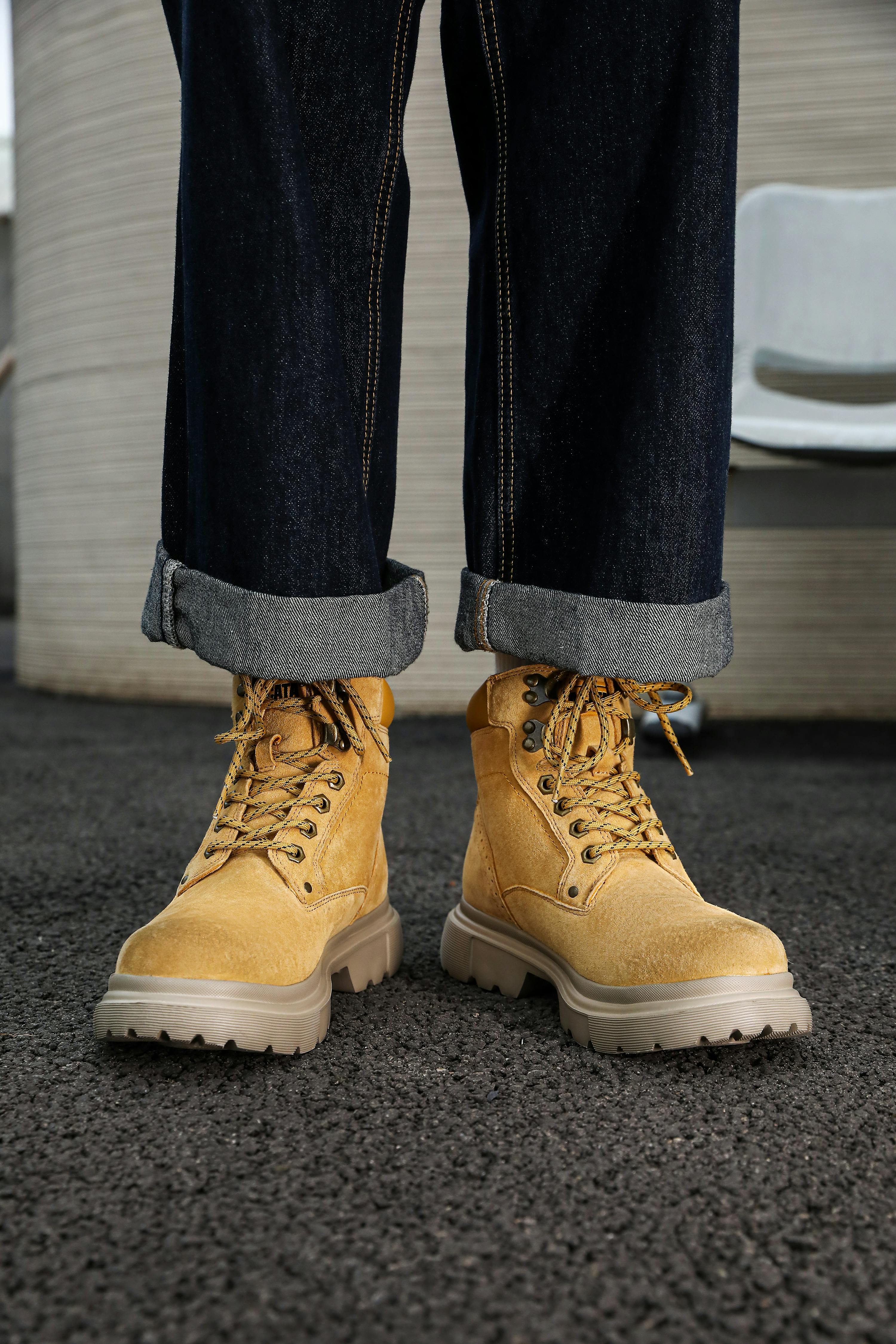 Stylish Yellow Work Boots on Denim Jeans · Free Stock Photo