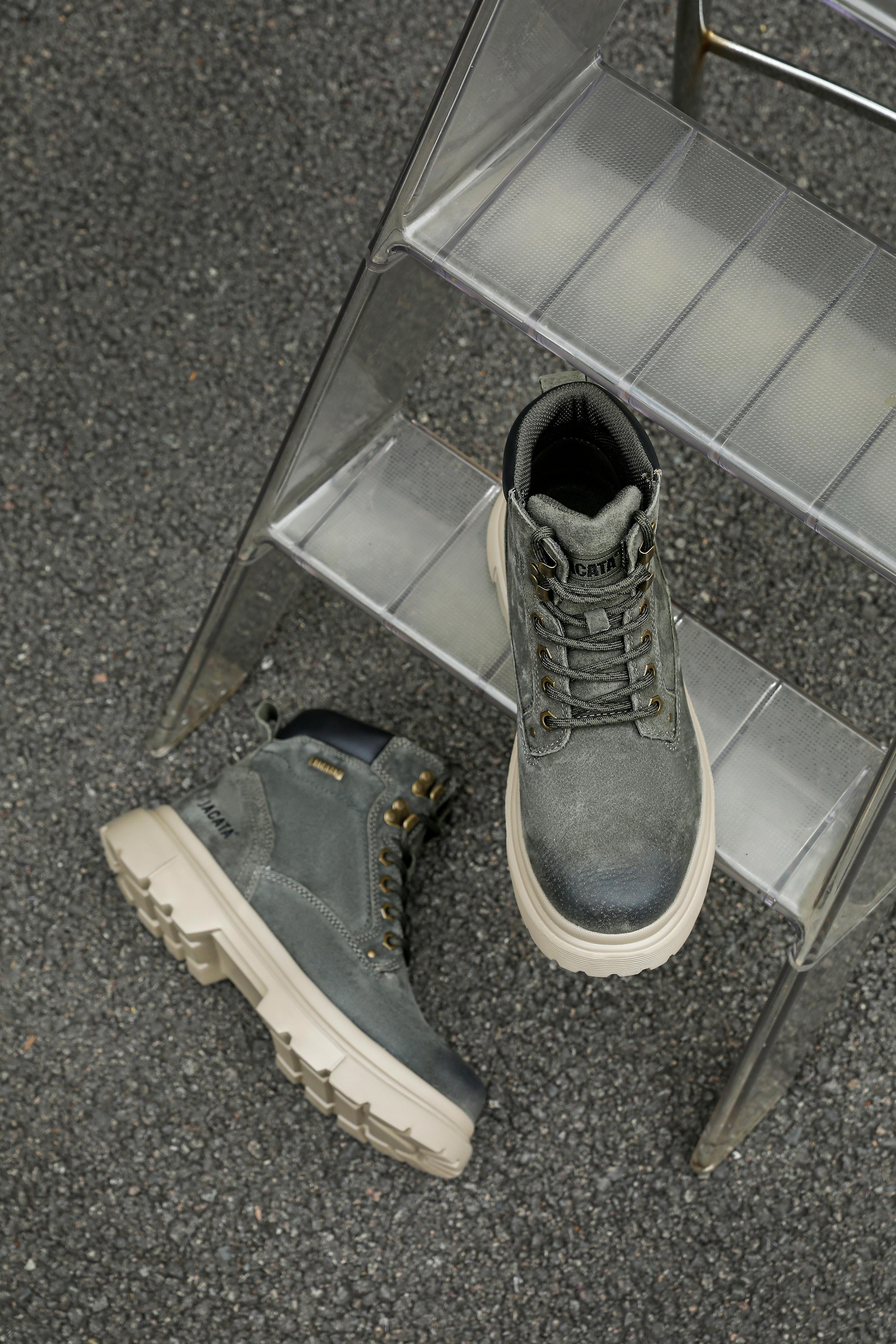 Stylish Outdoor Boots on Metal Ladder · Free Stock Photo