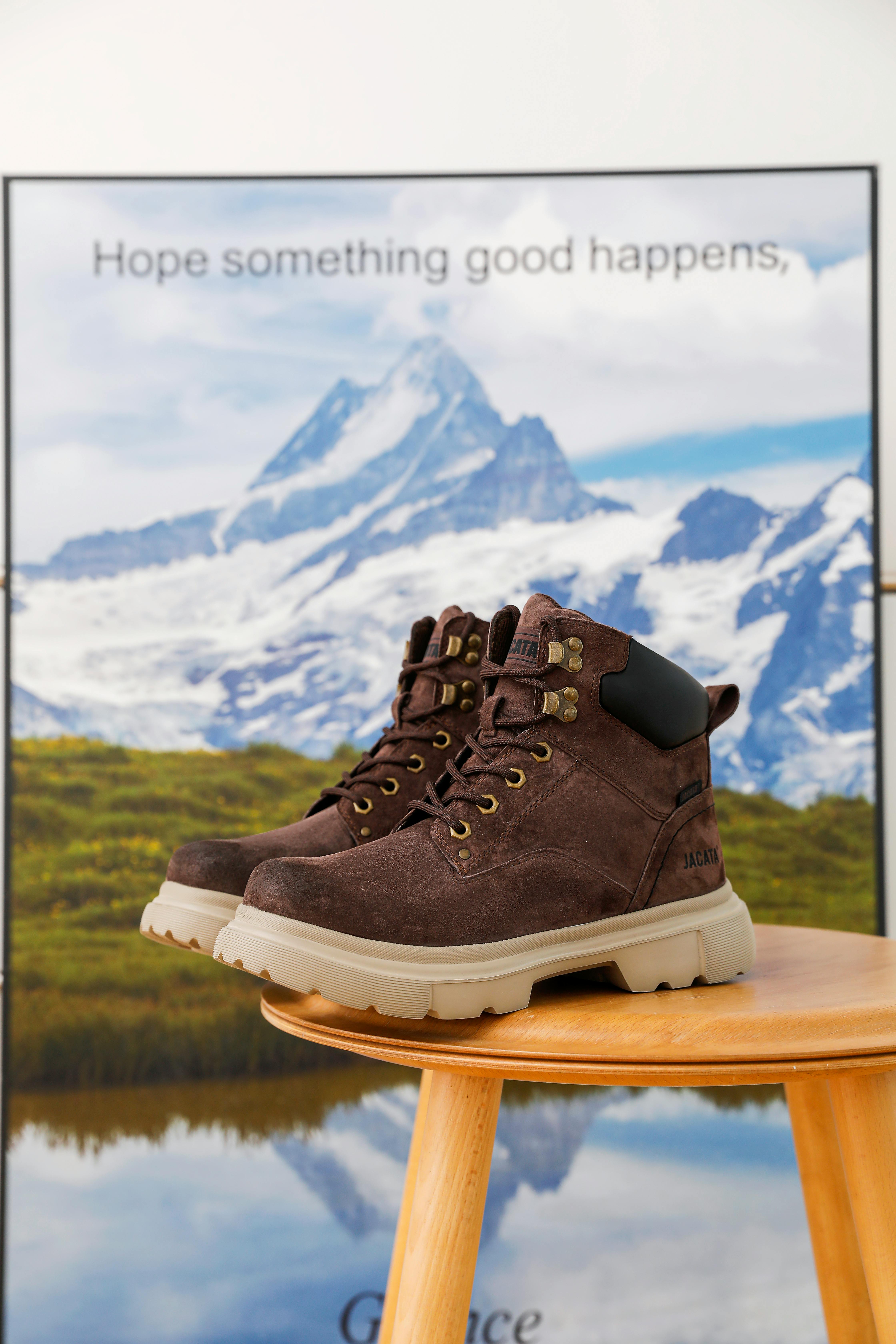 Brown Hiking Boots on Stool with Mountain Background · Free Stock Photo