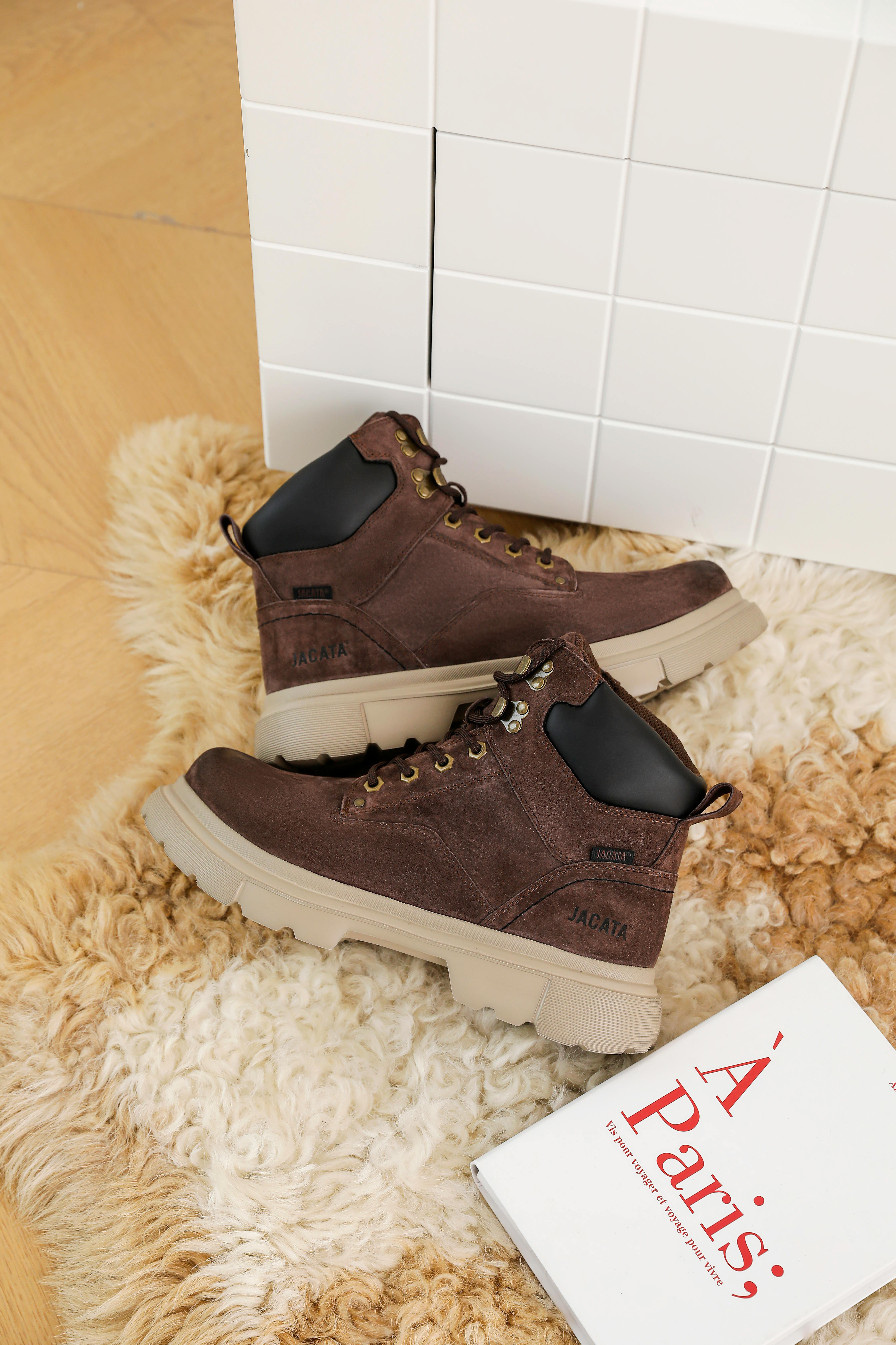 Stylish Brown Suede Hiking Boots on Cozy Rug · Free Stock Photo