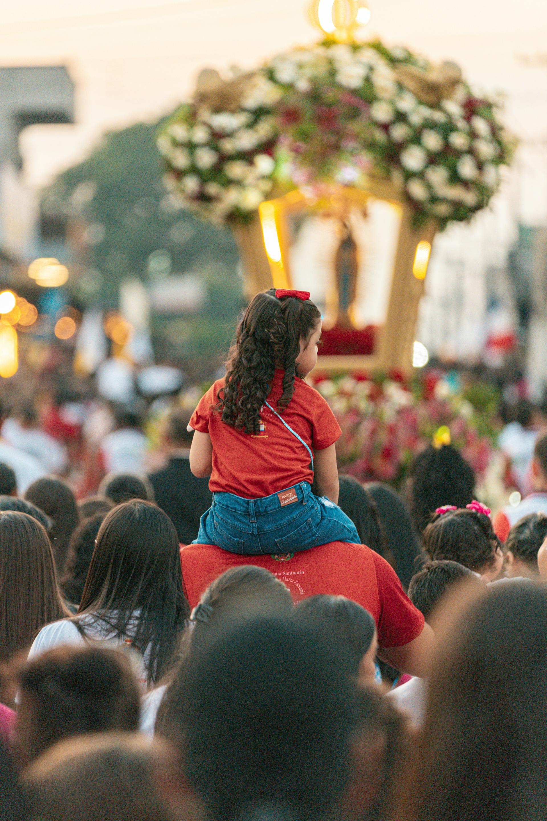 Child Witnessing Cultural Parade on Shoulders · Free Stock Photo
