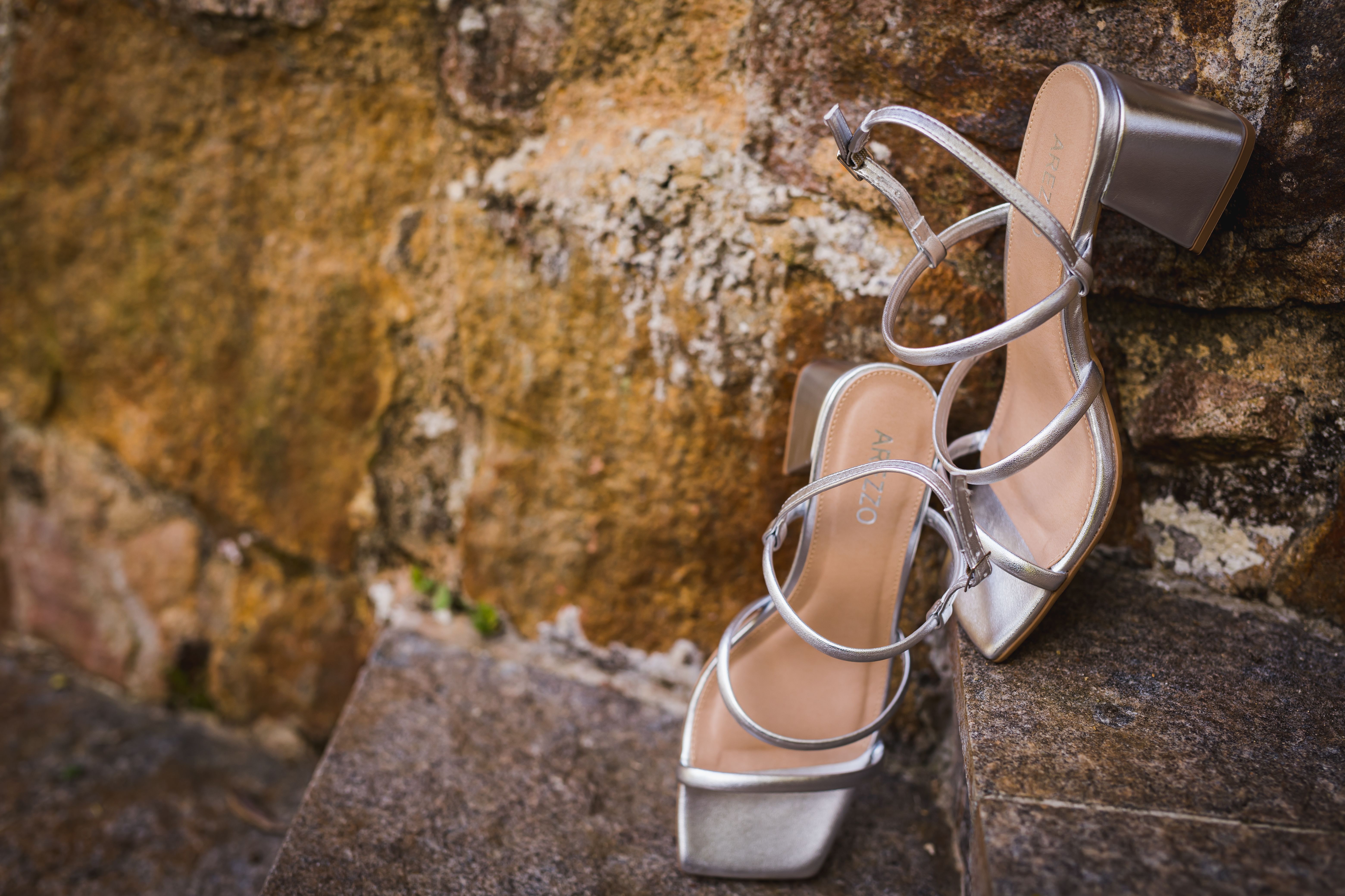 Elegant Silver Sandals on Rustic Stone Step · Free Stock Photo