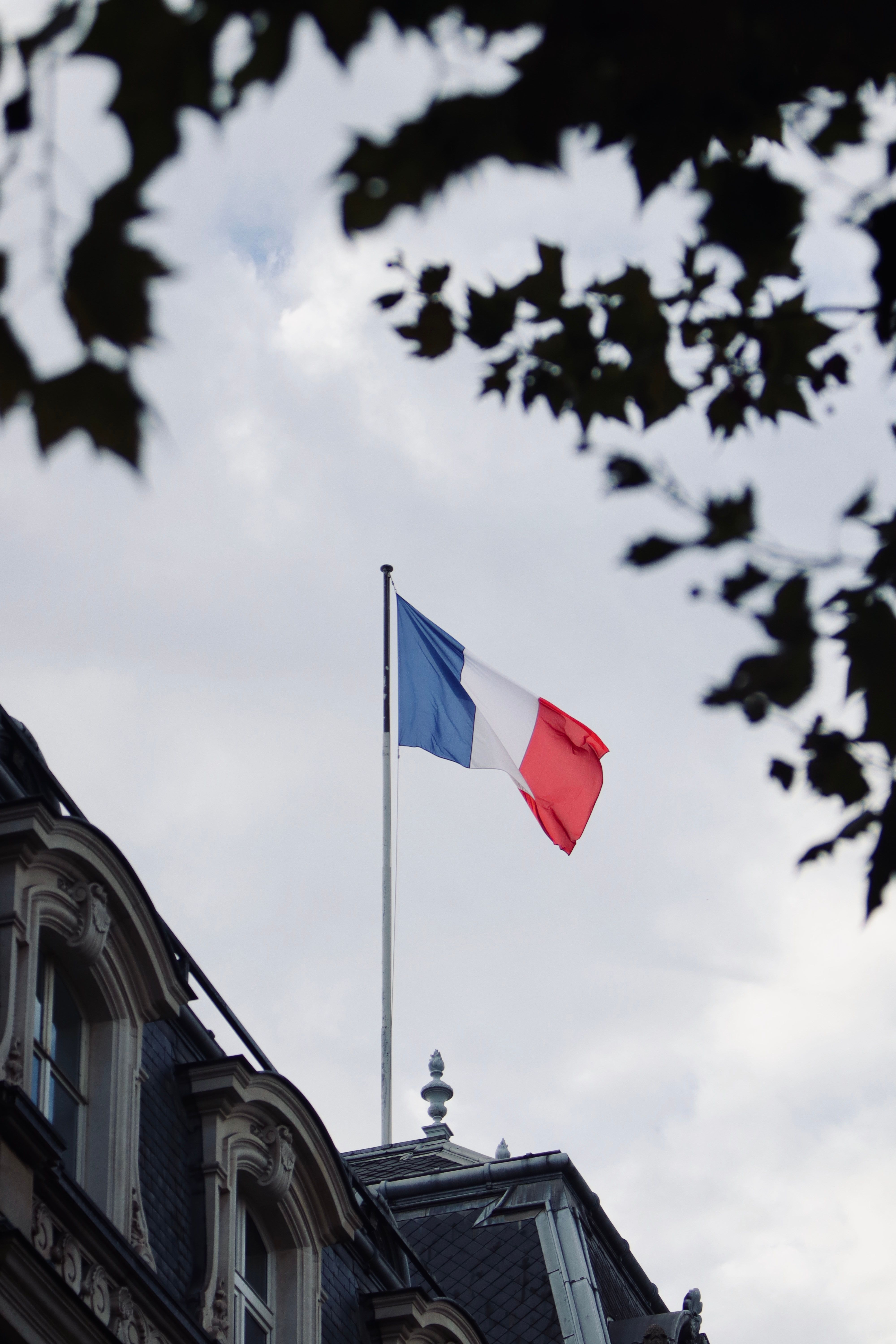 French national flag over historical building · Free Stock Photo