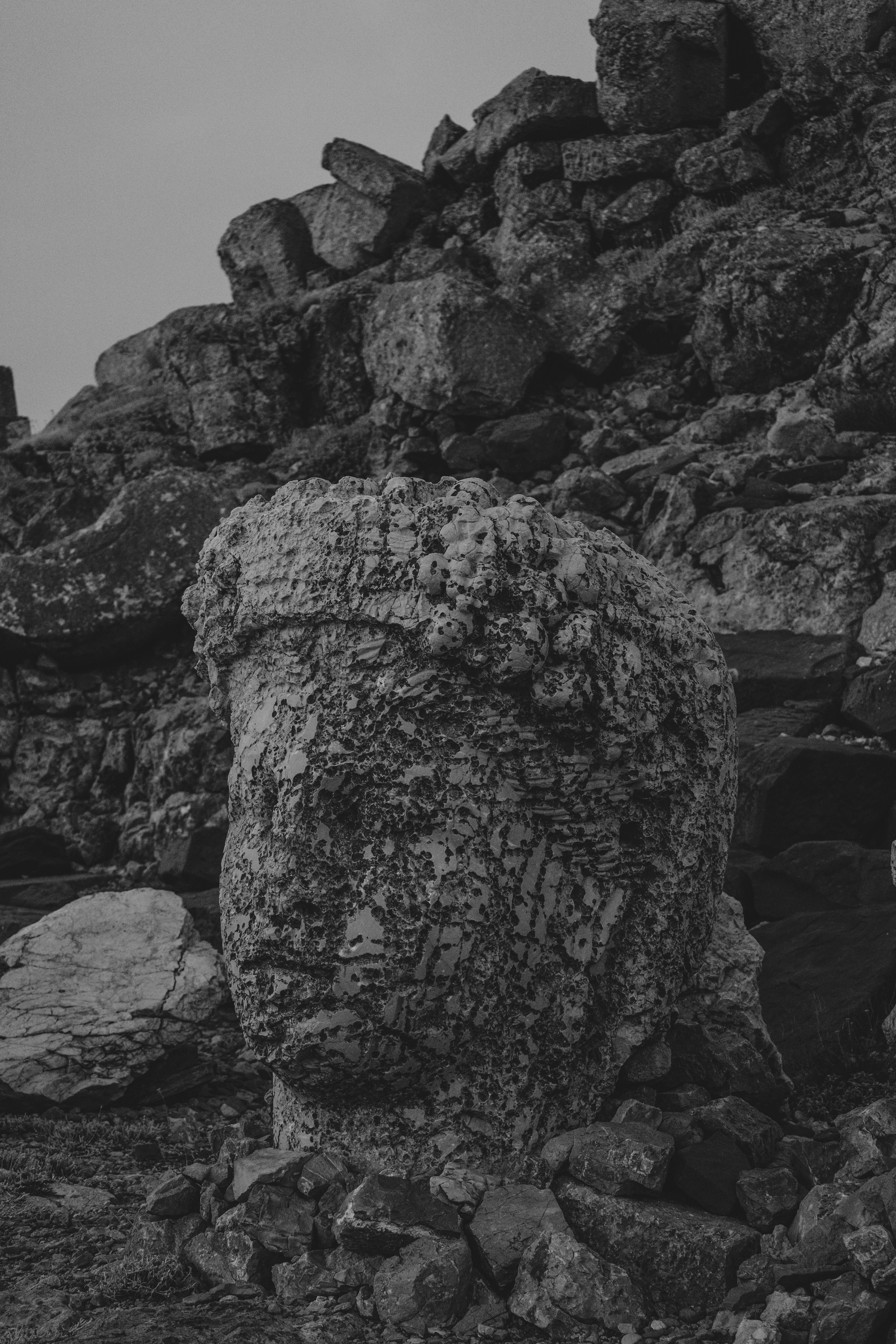 Ancient Stone Statue Amidst Rocky Ruins · Free Stock Photo