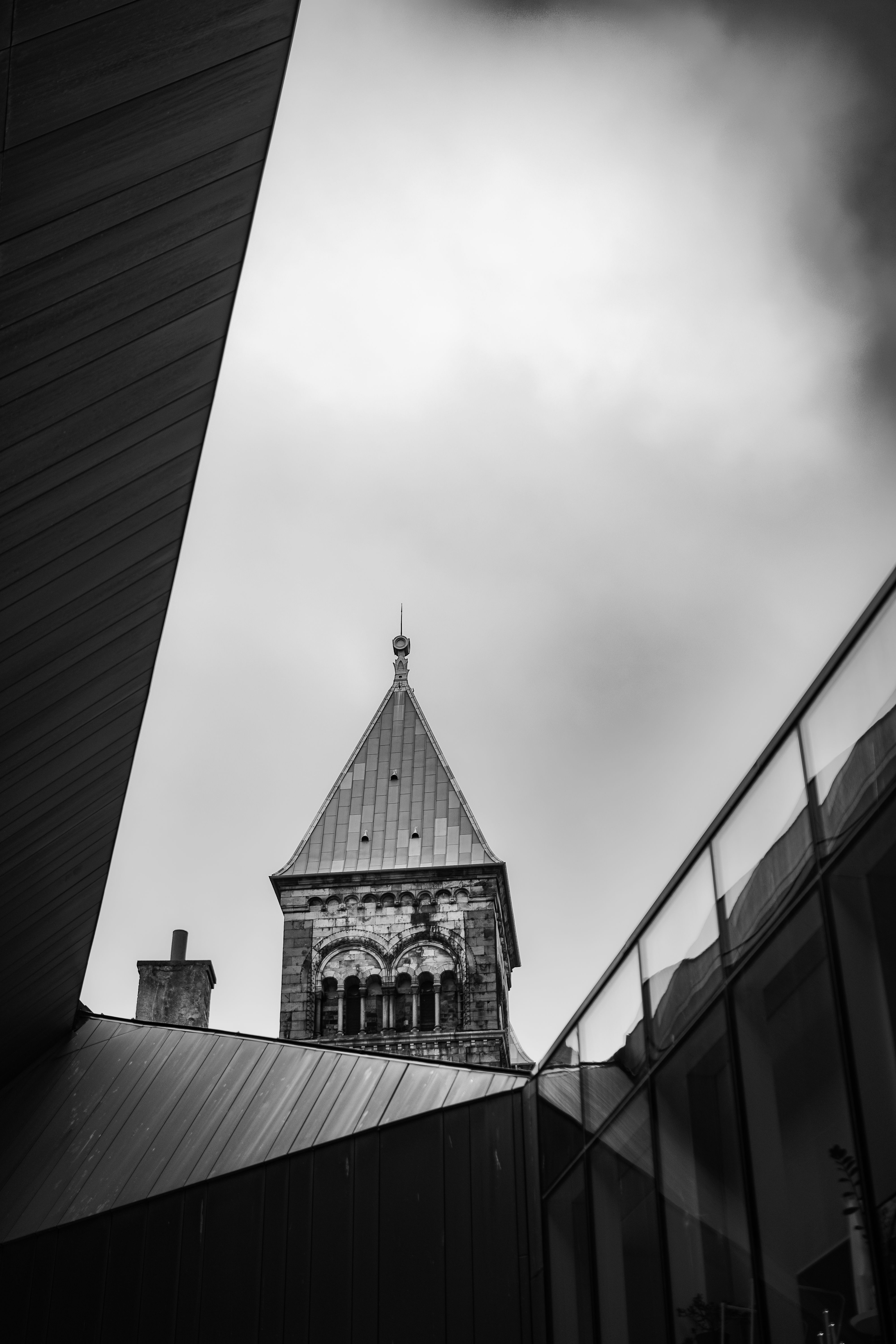 Lund Cathedral Tower through Modern Architecture · Free Stock Photo