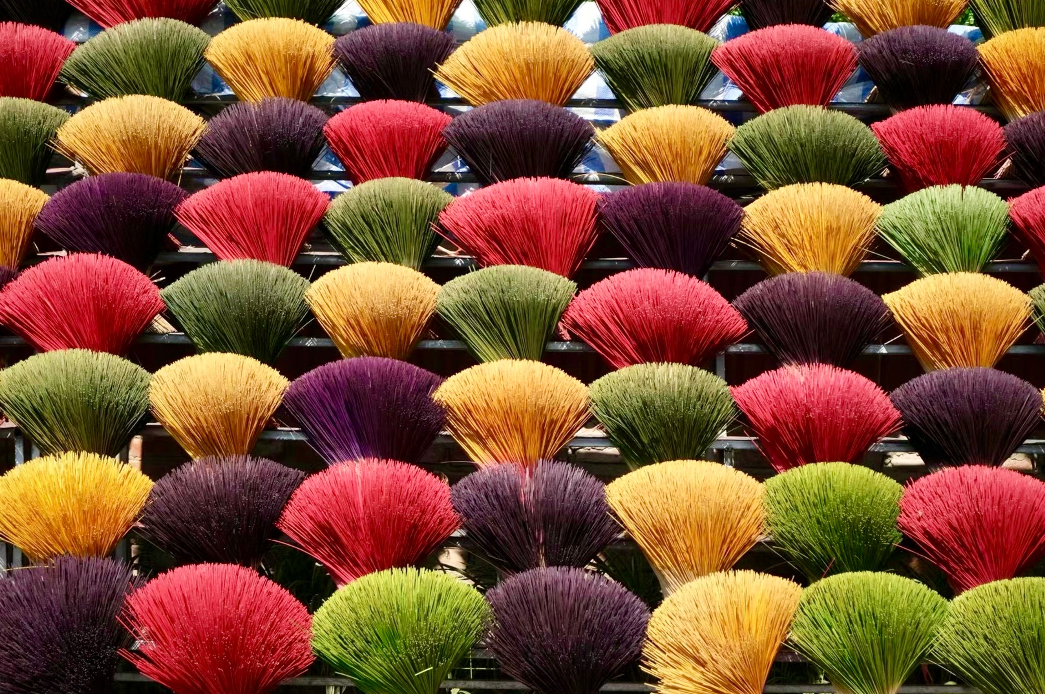 Colorful Display of Traditional Brooms · Free Stock Photo