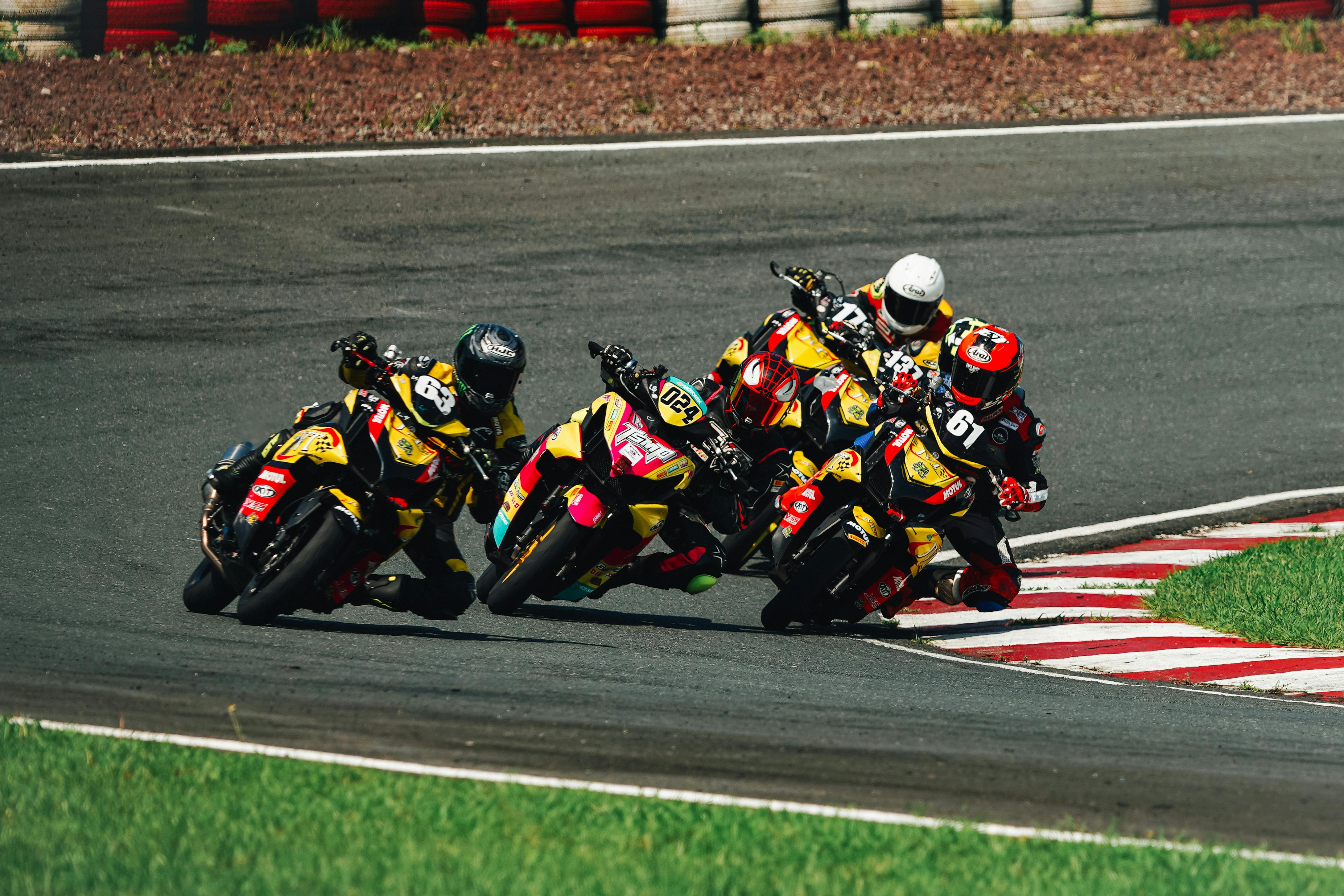 Exciting Motorcycle Race on Curved Track · Free Stock Photo
