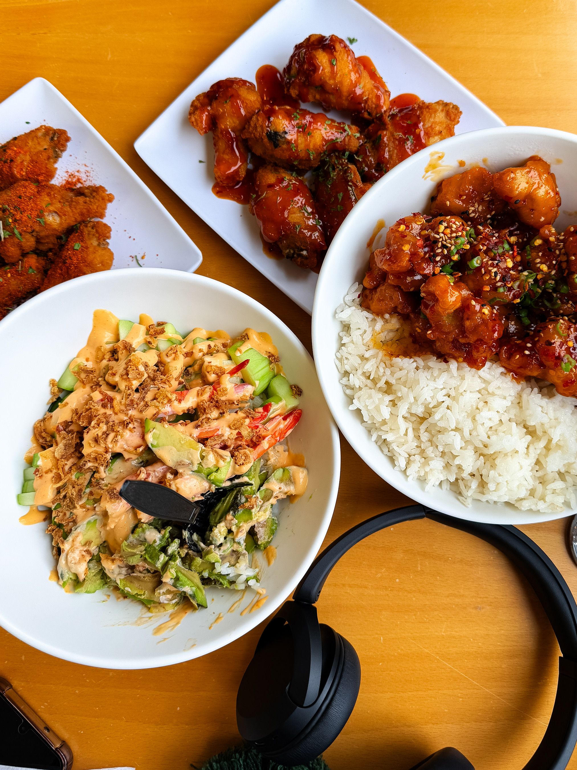 Delicious Asian Fusion Meals on Wooden Table · Free Stock Photo