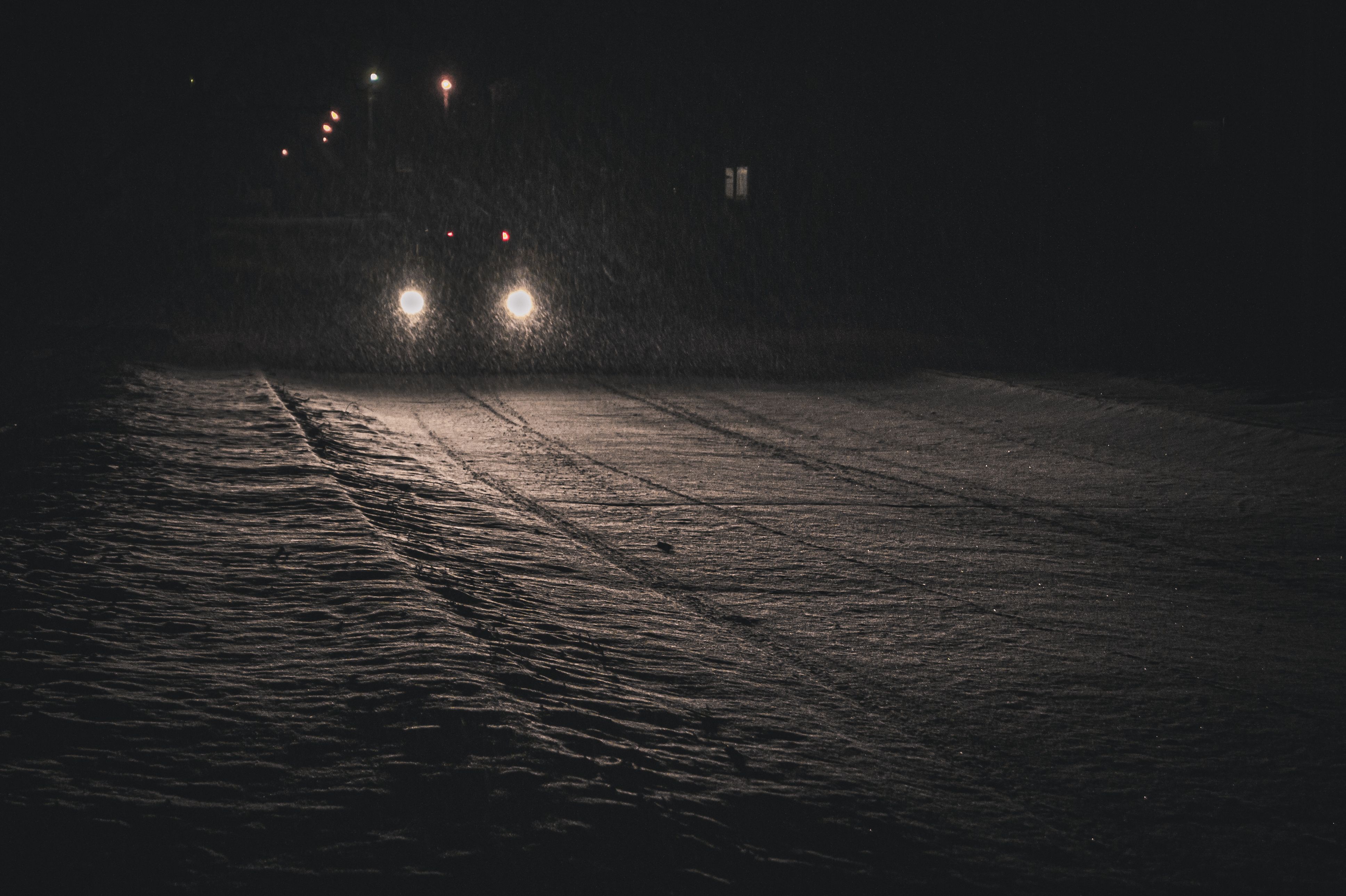 Car Headlights Illuminating Snowy Night Road · Free Stock Photo