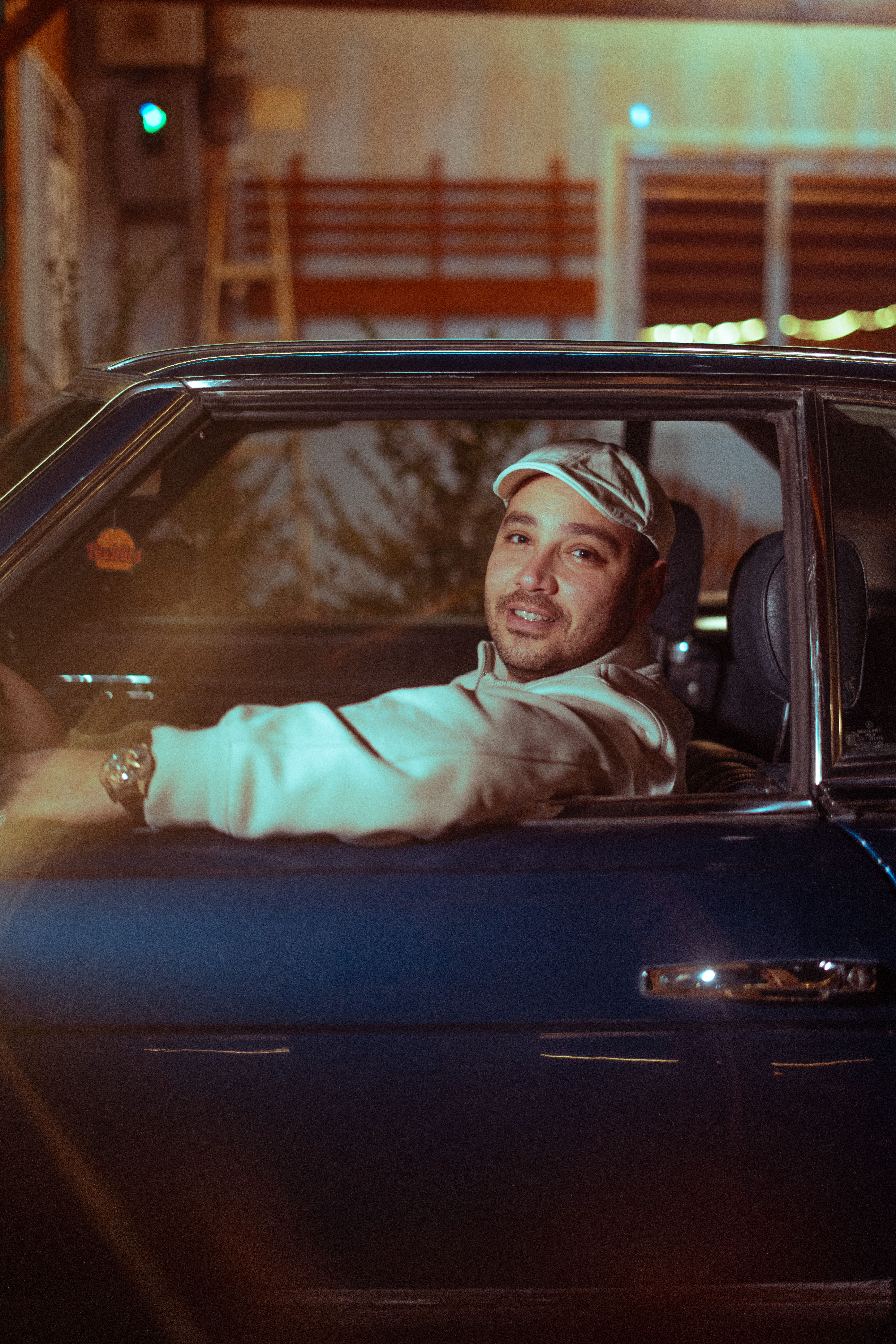 Man Showing Peace Sign from Classic Car Window · Free Stock Photo