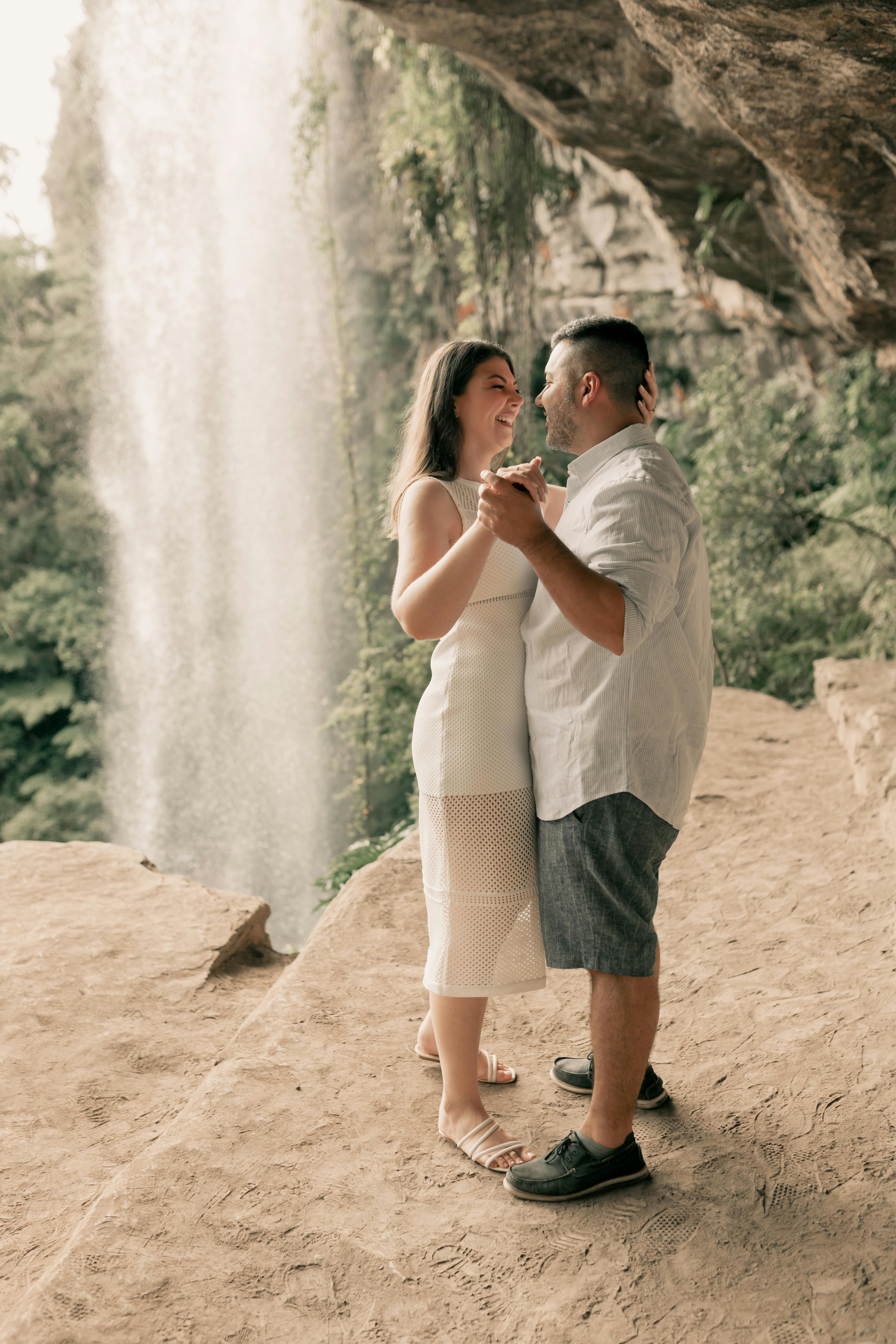Romantic Couple Dancing Beside a Waterfall · Free Stock Photo