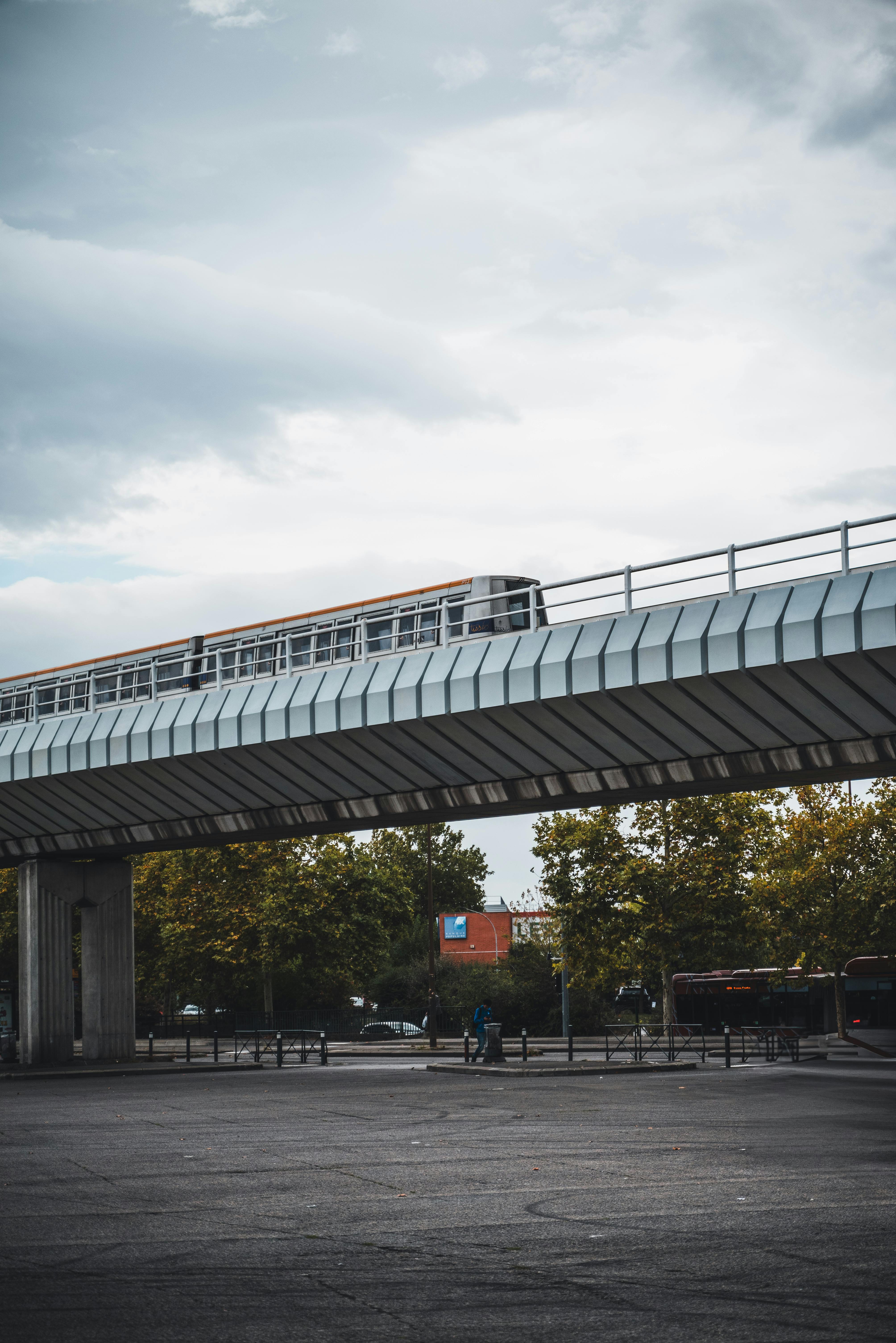 Modern Train Crossing Elevated Railway Bridge in France · Free Stock Photo