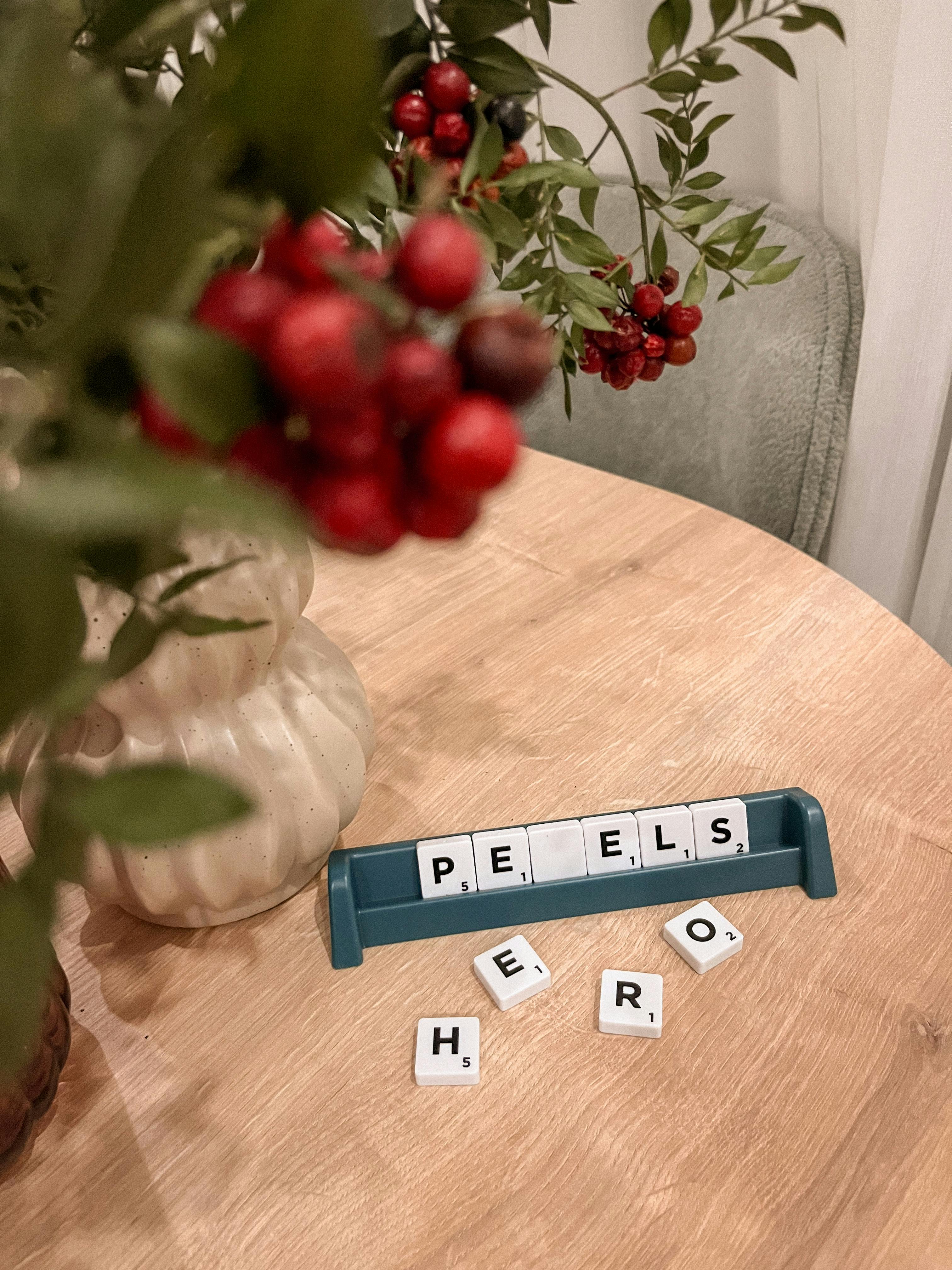 Scrabble Tiles and Red Berries on Wooden Table · Free Stock Photo