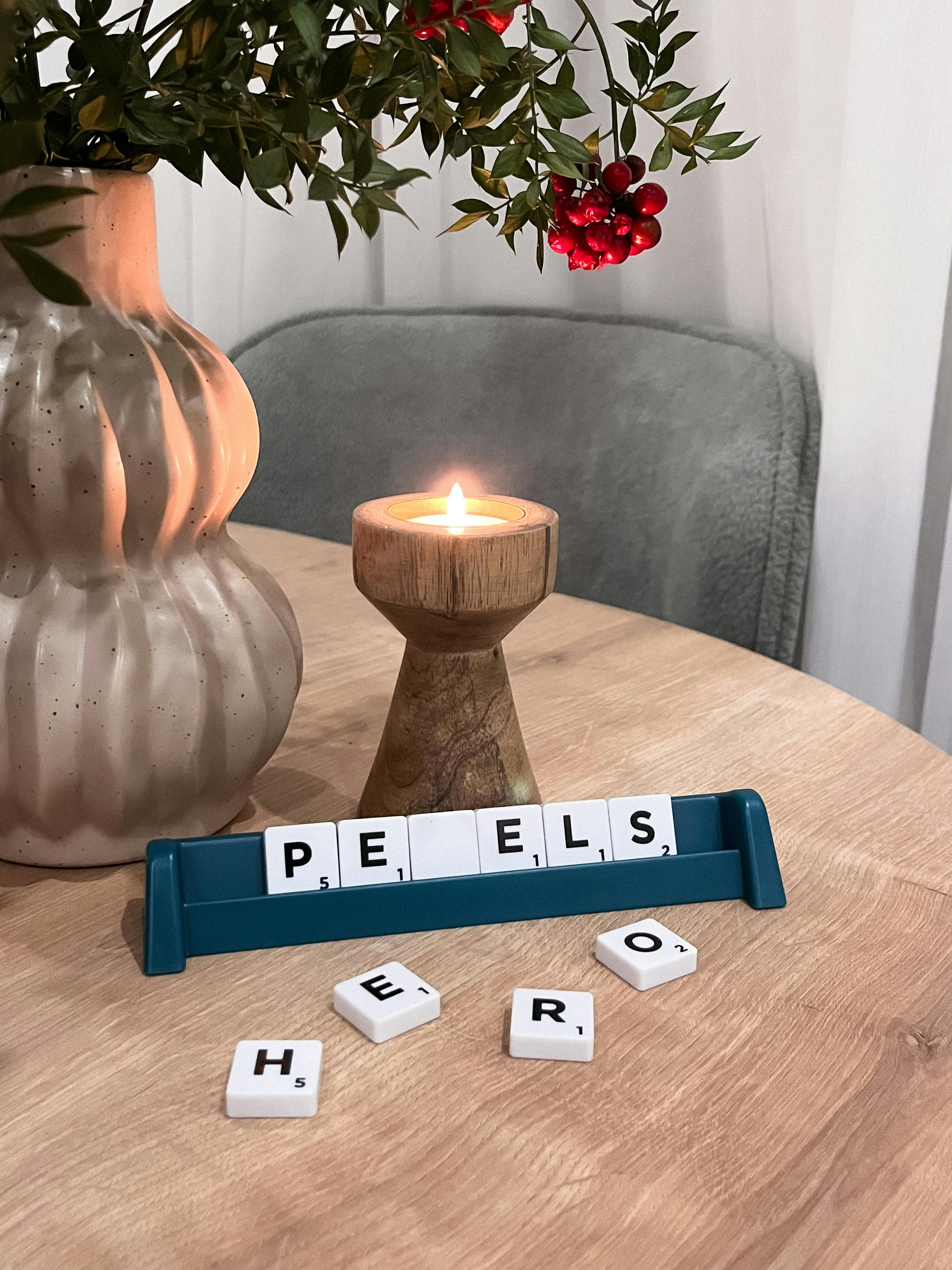 Cozy Still Life with Candle and Scrabble Tiles · Free Stock Photo