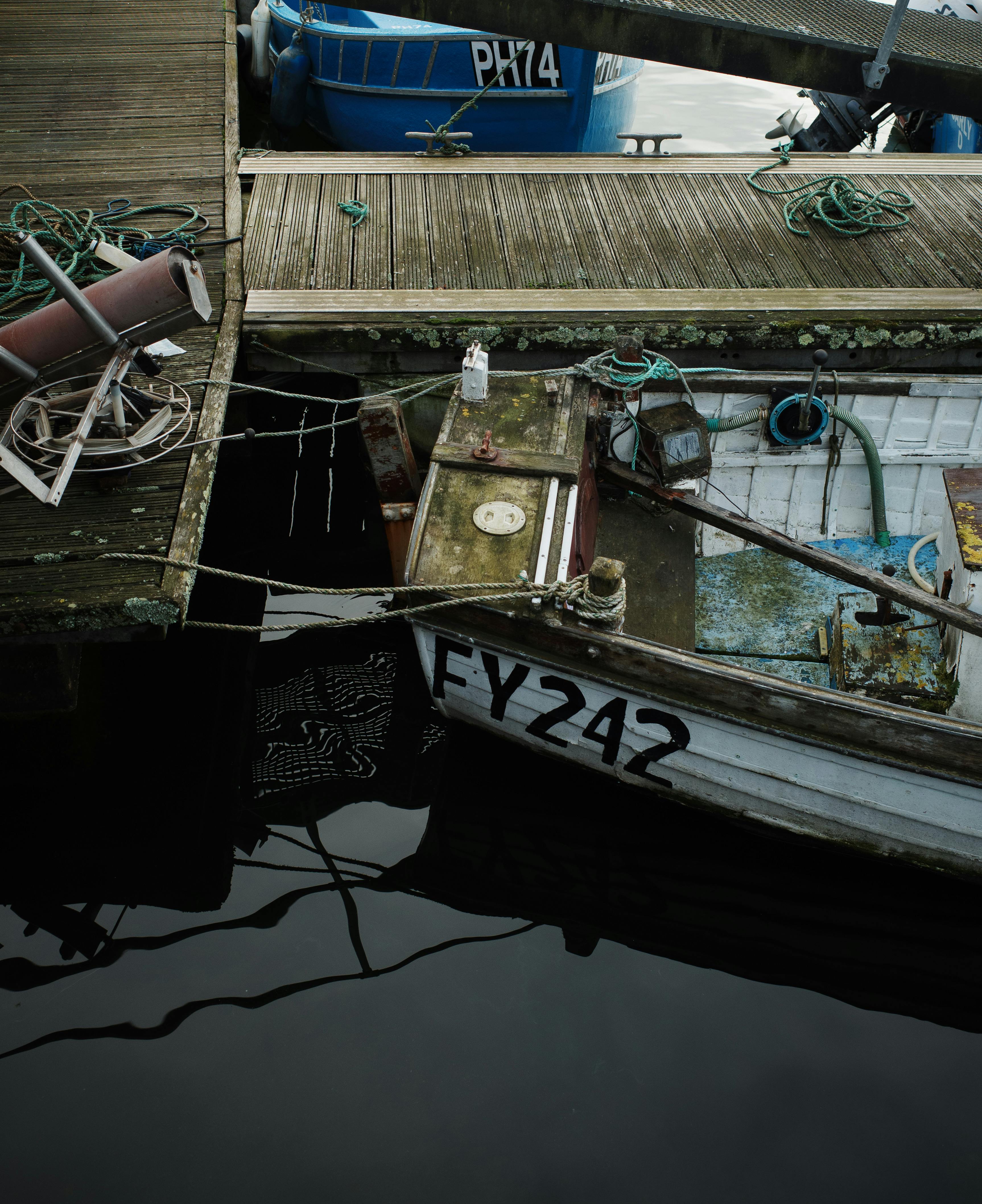 Rustic Fishing Boat Moored at Wooden Dock · Free Stock Photo