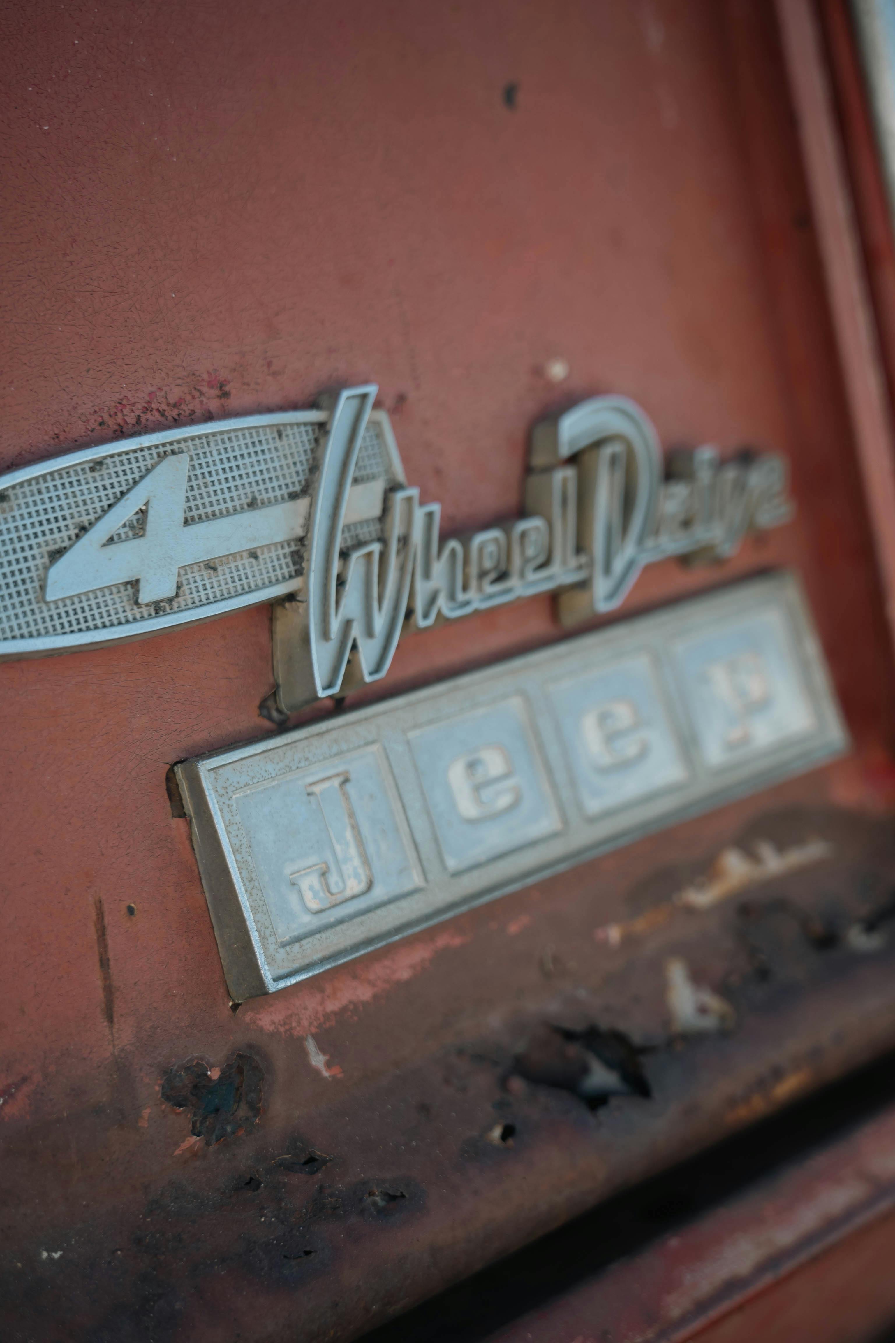 Close-up of Vintage Jeep Emblem with Rust · Free Stock Photo
