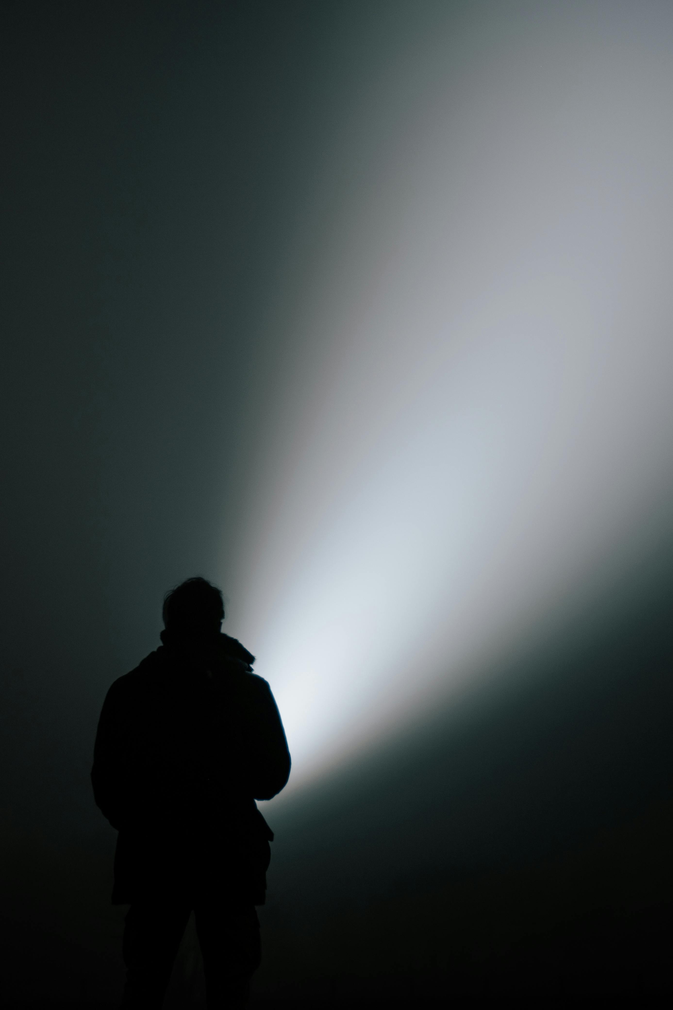 Silhouette in Dense Fog with Flashlight Beam · Free Stock Photo