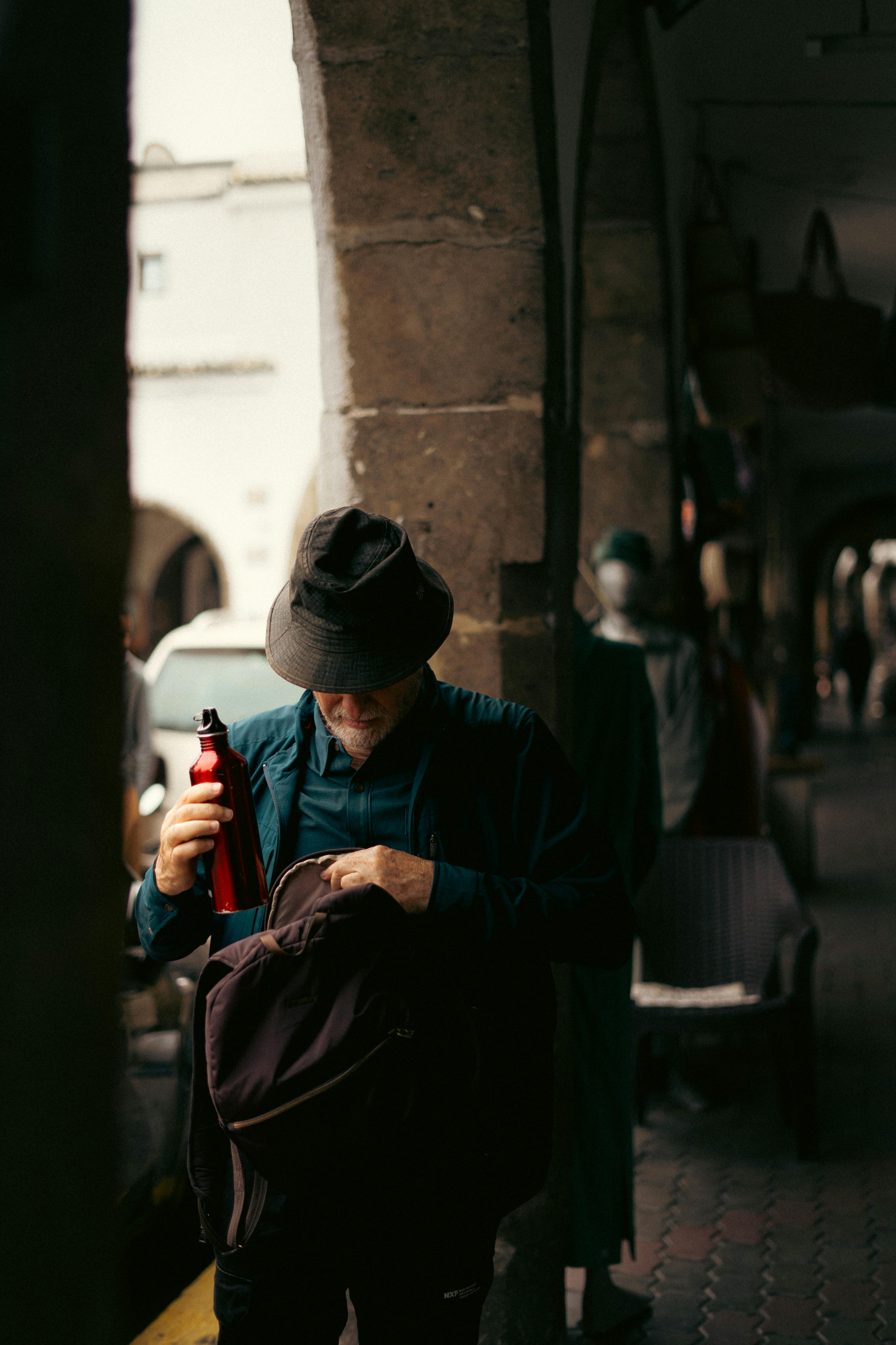 Outdoor Urban Scene with Man and Backpack · Free Stock Photo