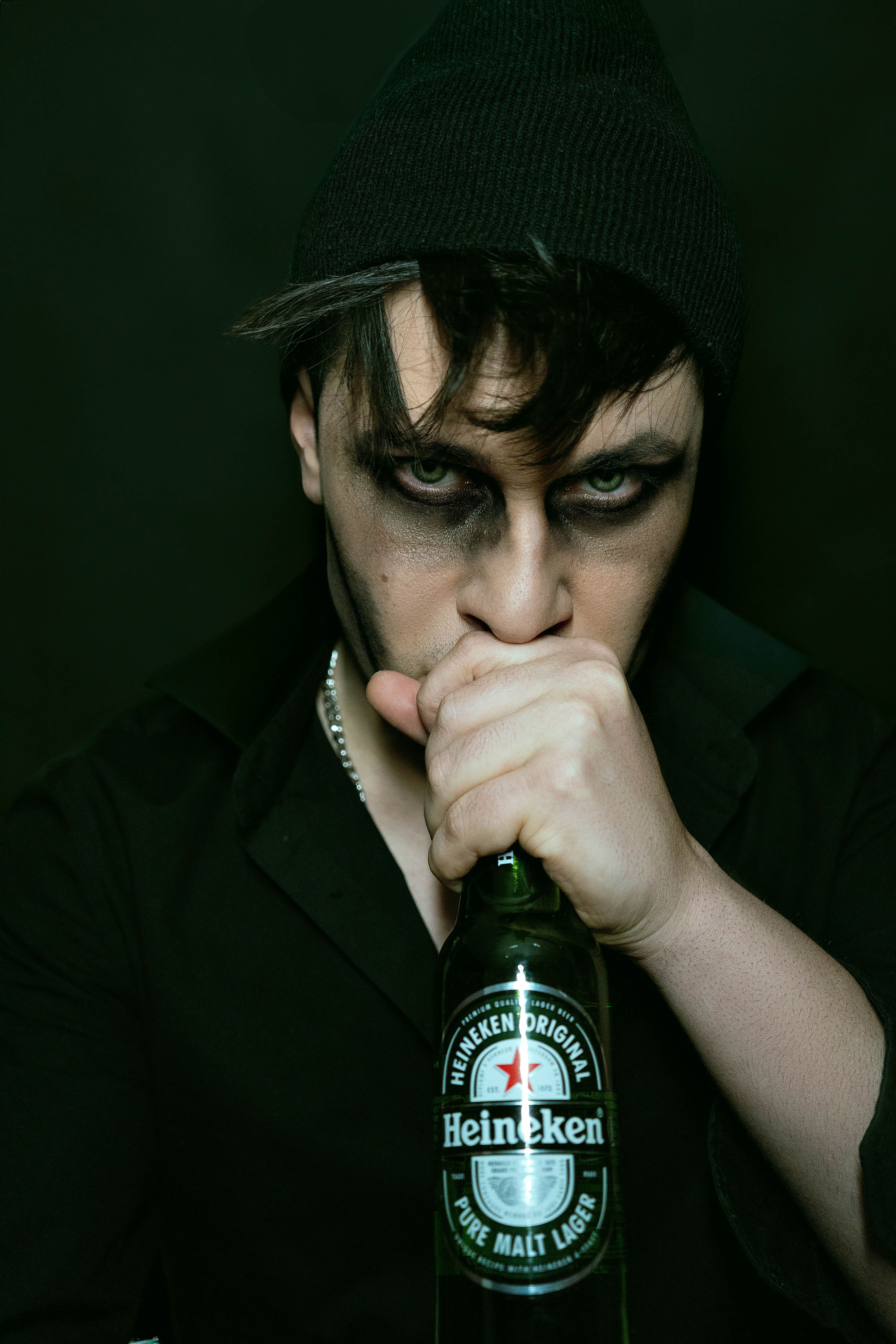 Dark Portrait with Heineken Bottle in Hand · Free Stock Photo