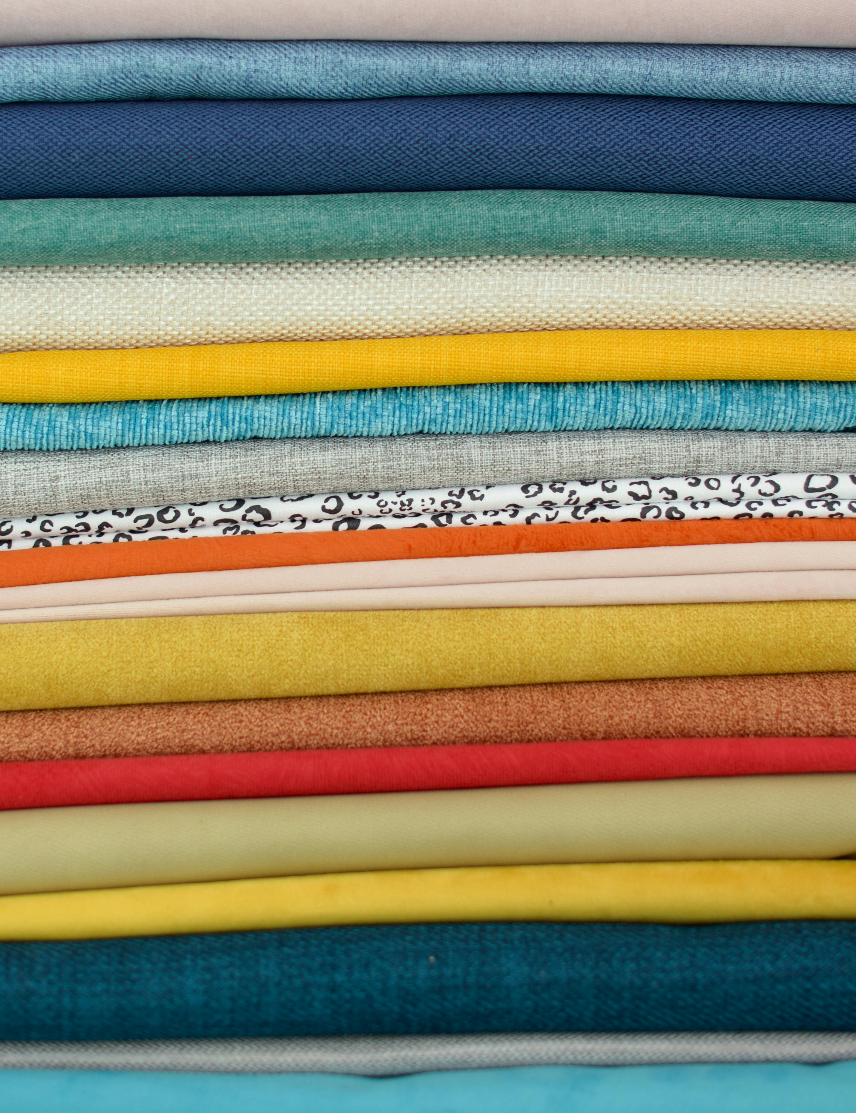 Stack of Colorful Fabrics Displayed Horizontally · Free Stock Photo