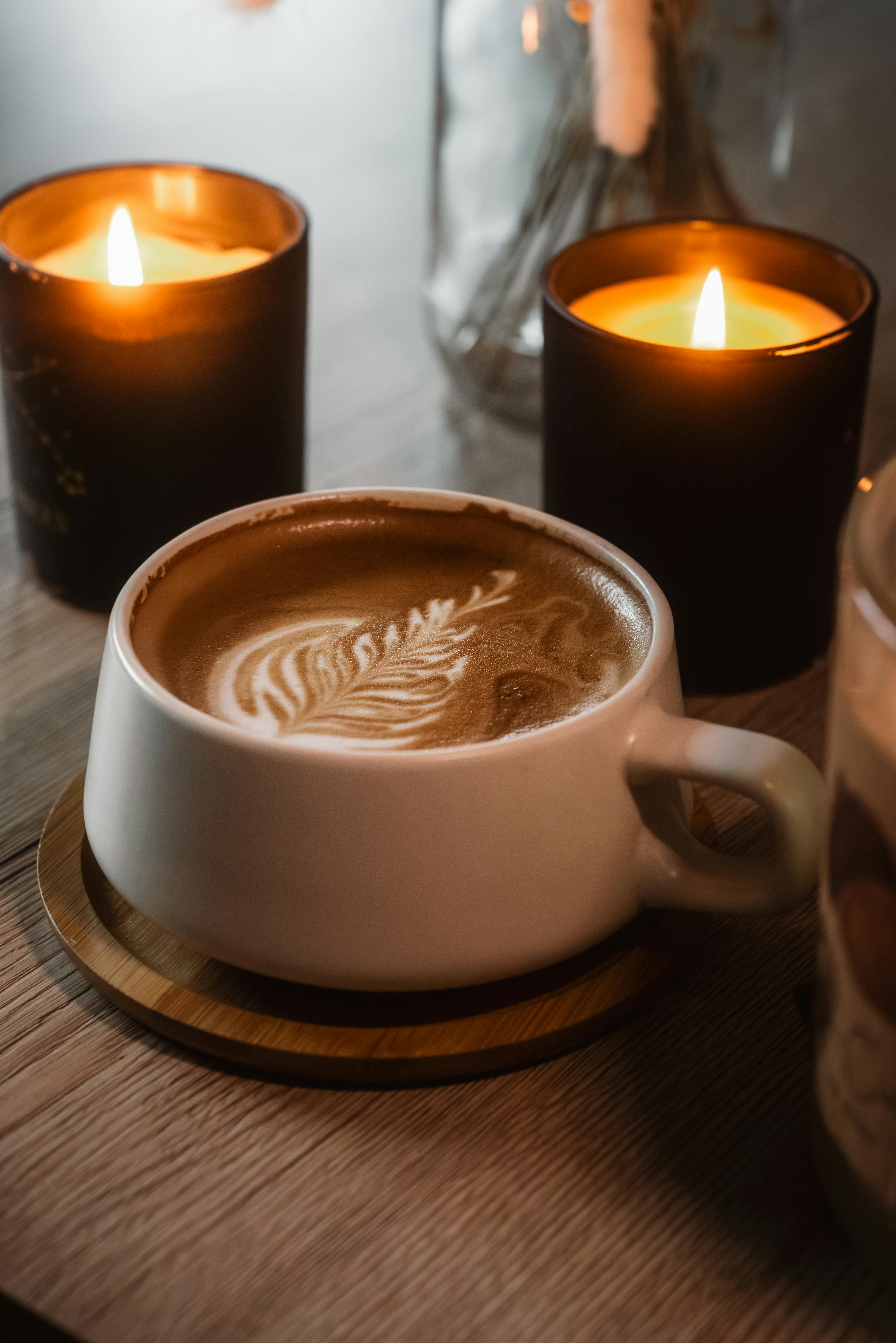 Cozy Coffee Moment with Flickering Candlelight · Free Stock Photo