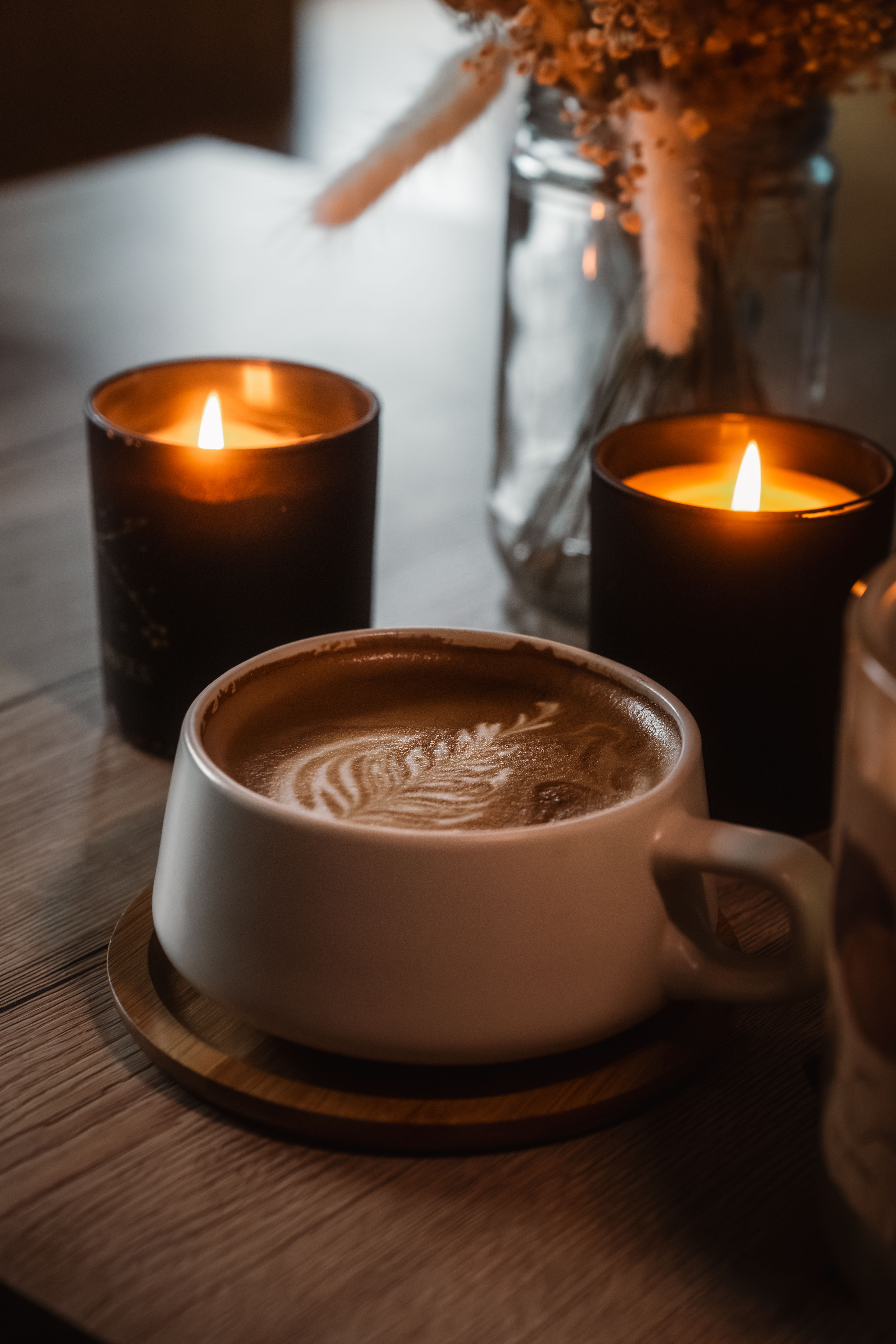 Cozy Coffee Moment with Latte Art and Candlelight · Free Stock Photo