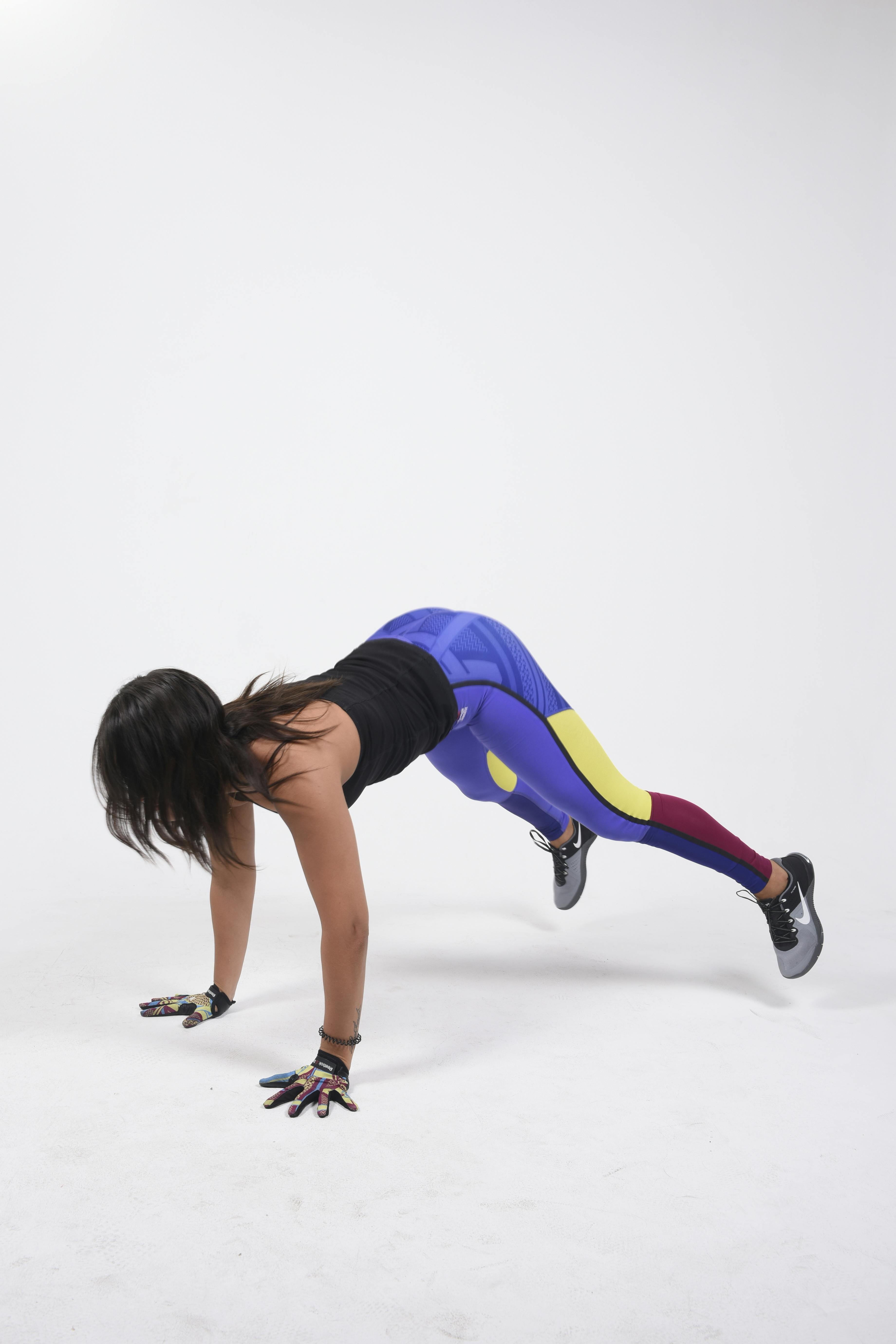 Female Athlete Performing Burpee in Studio Setting · Free Stock Photo