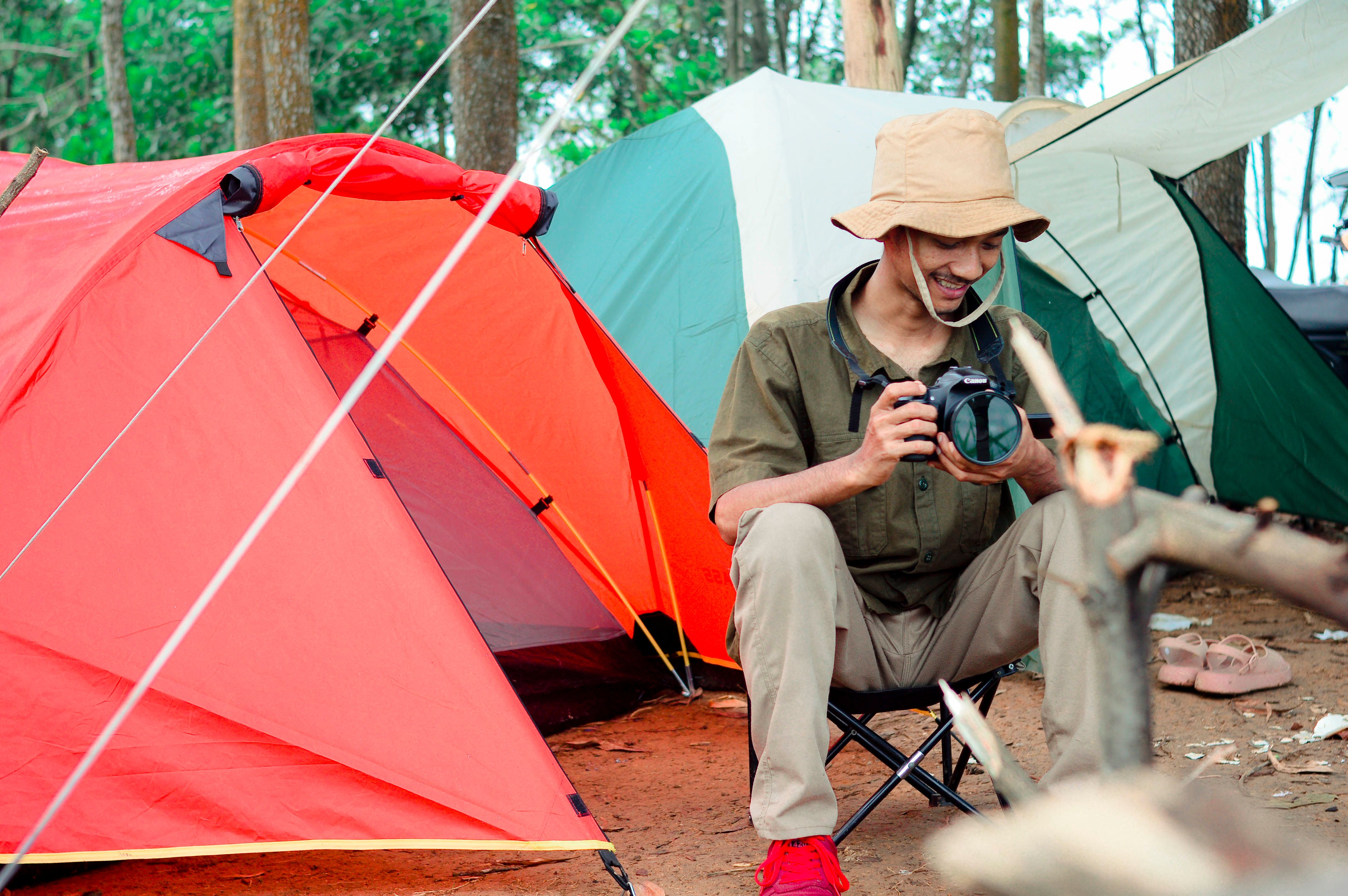 Young Camper Enjoying Photography in Forest · Free Stock Photo