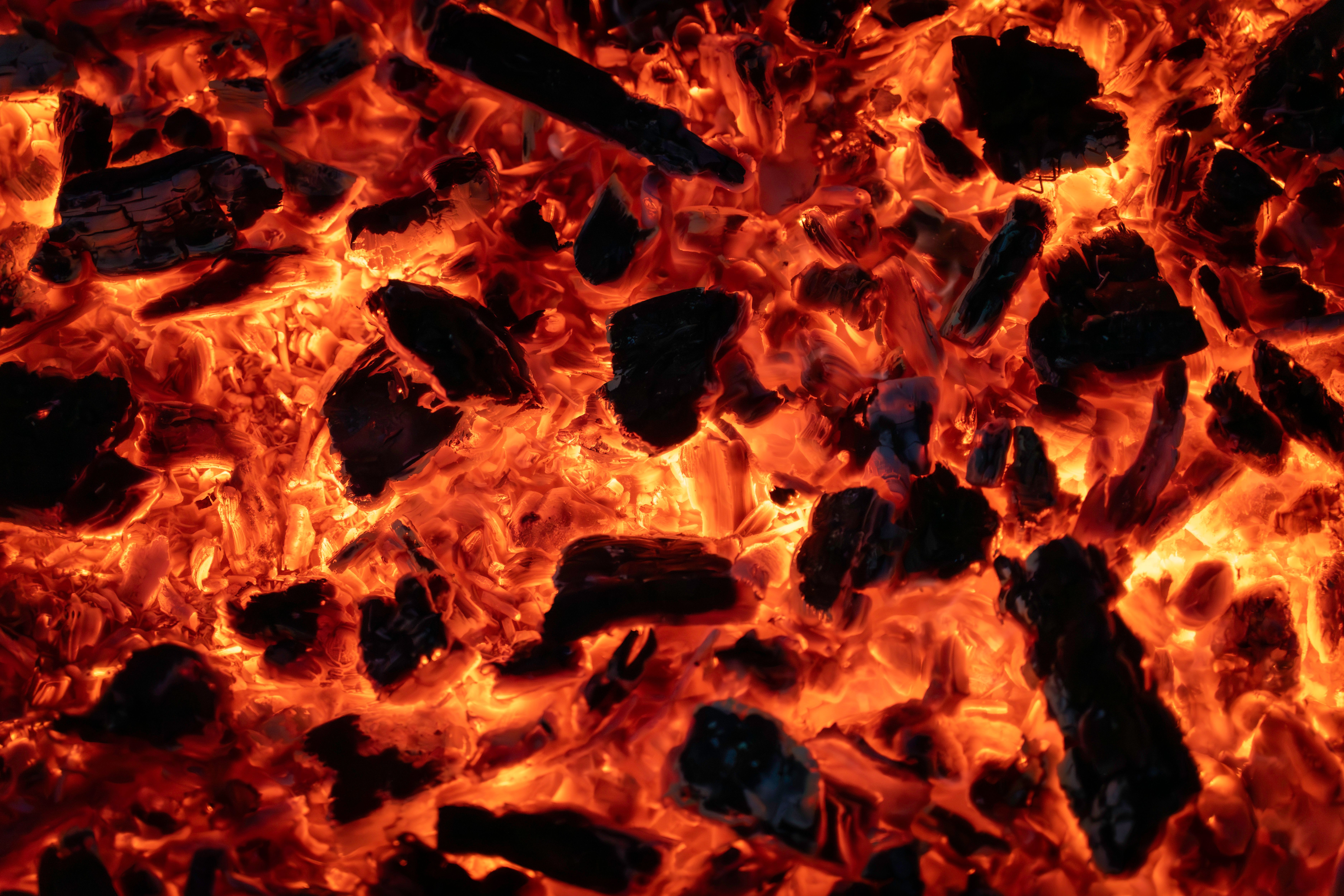 Glowing Hot Coals and Charred Wood Close-up · Free Stock Photo