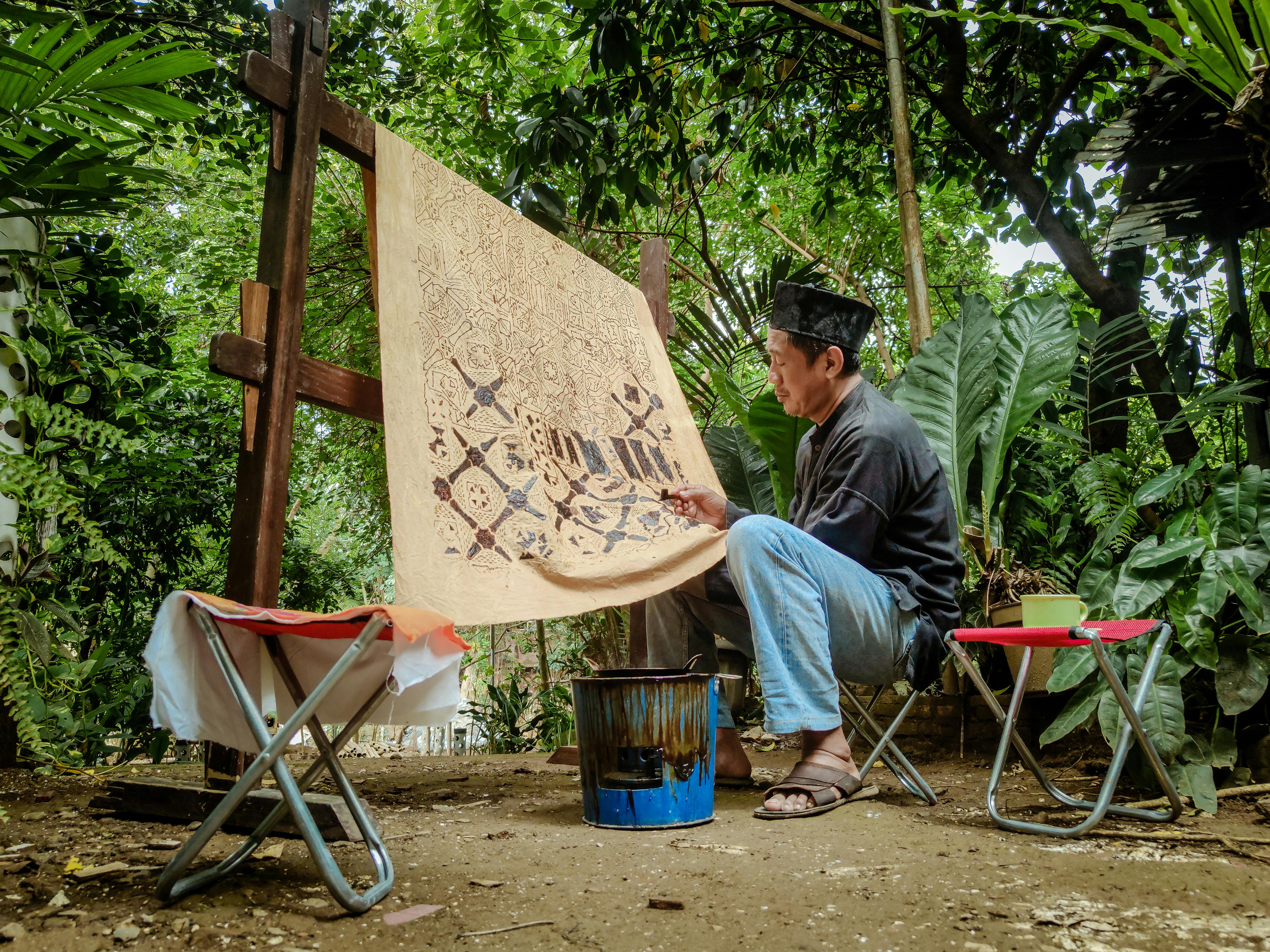 Traditional Batik Artist Crafting Outdoors · Free Stock Photo