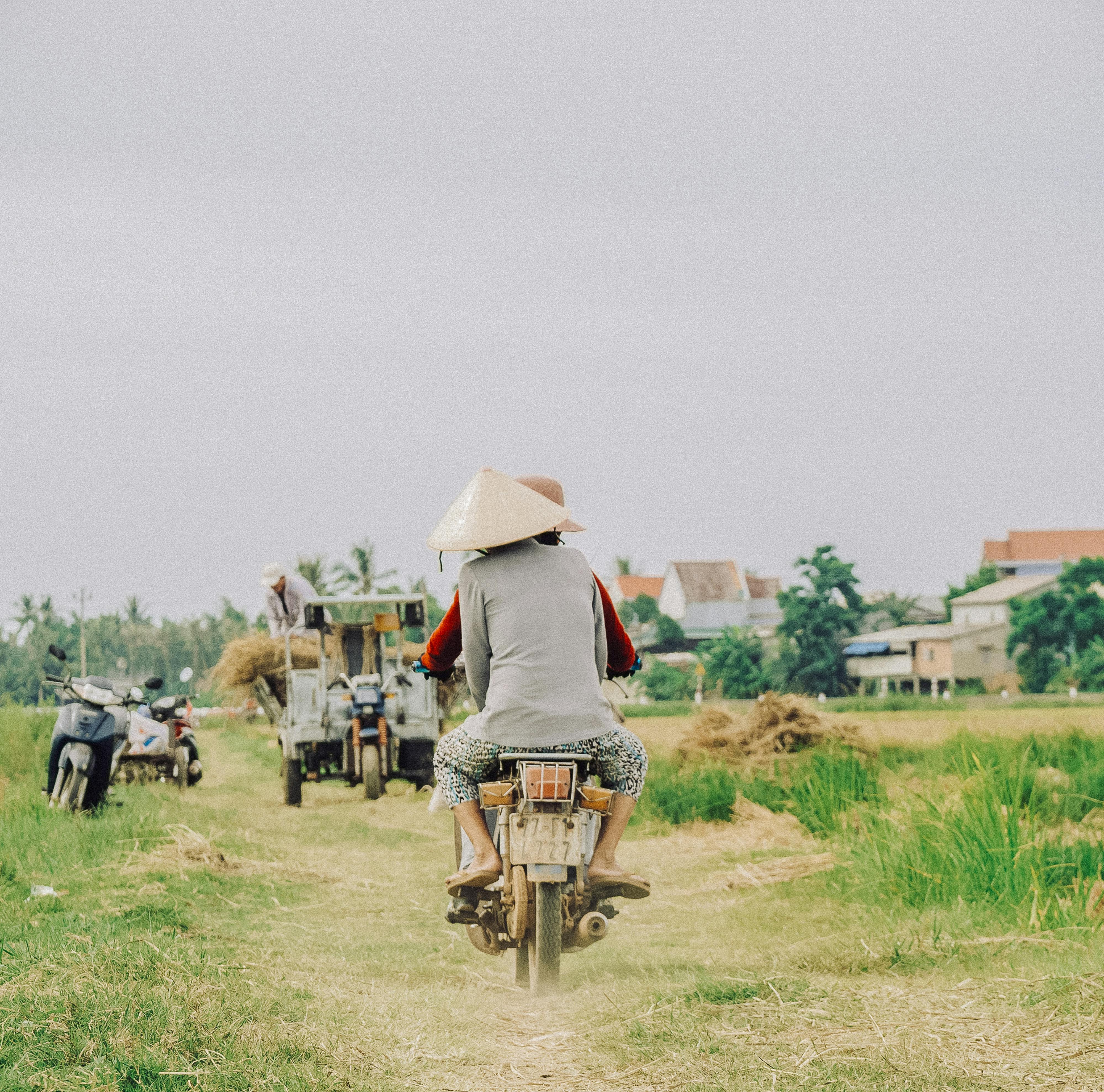Traditional Vietnamese Farmer Riding Motorcycle · Free Stock Photo