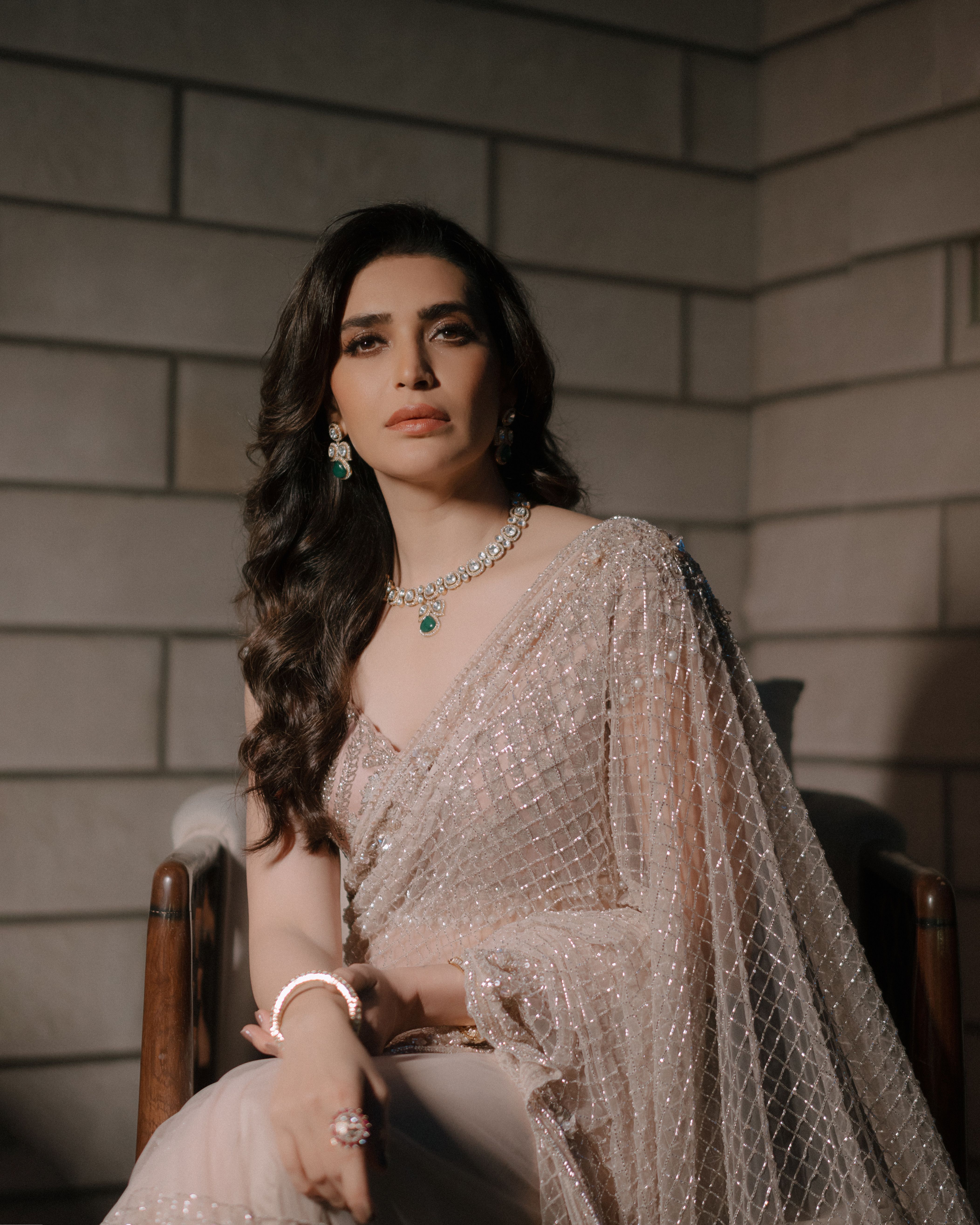 Elegant Woman in Designer Saree Sitting Indoors · Free Stock Photo