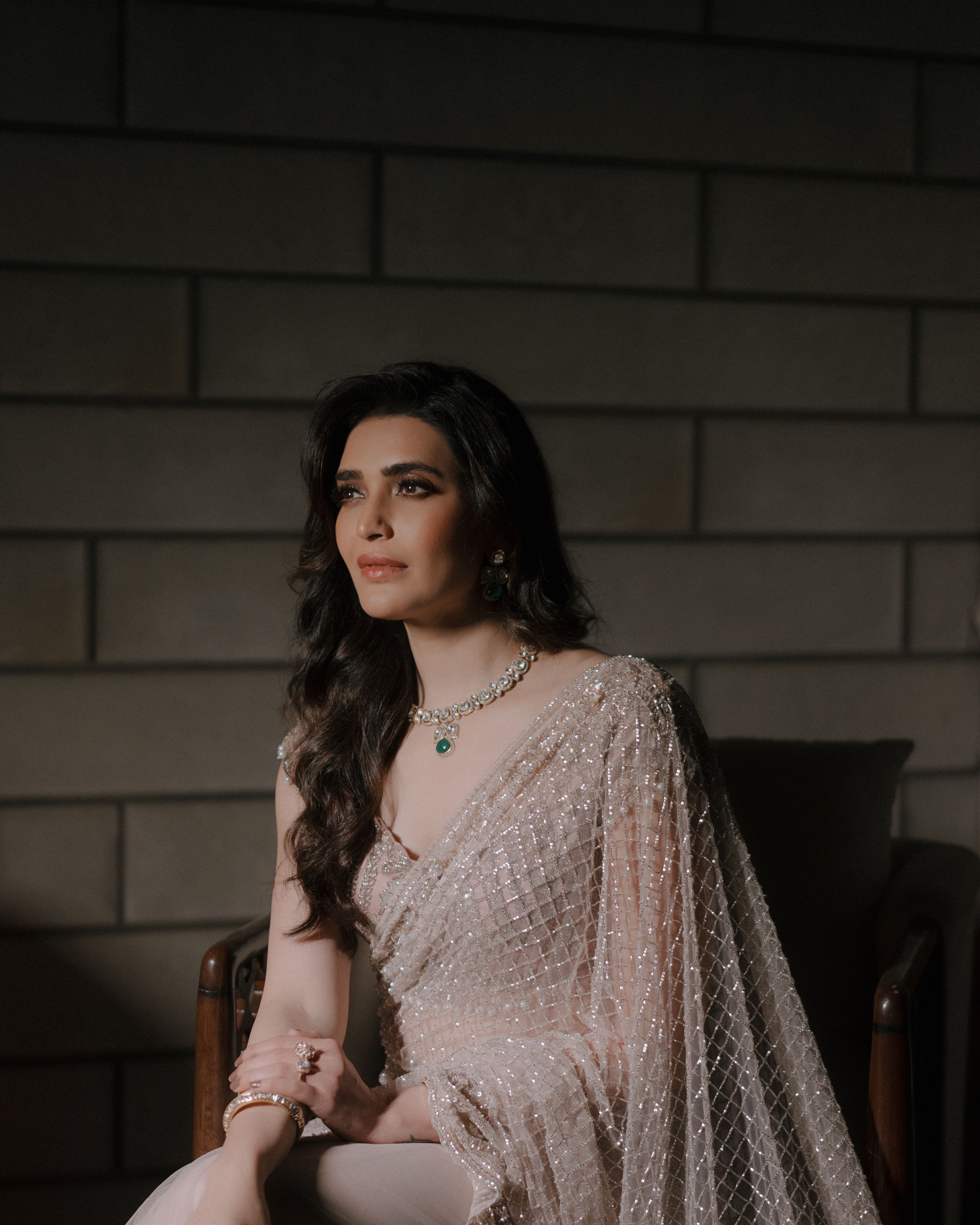 Elegant Woman in Bejeweled Saree Sitting Indoors · Free Stock Photo