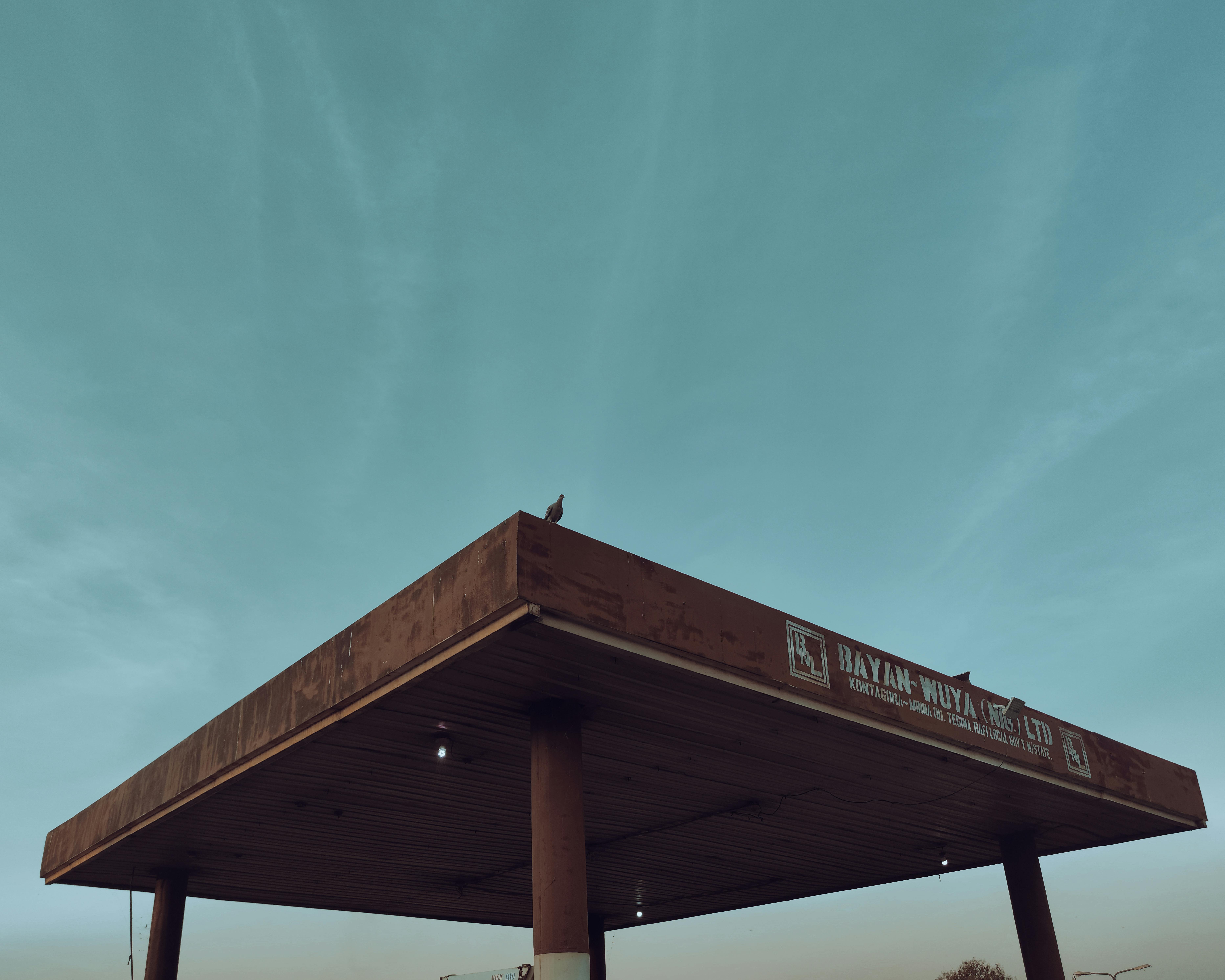 Urban Gas Station Canopy under Blue Sky · Free Stock Photo