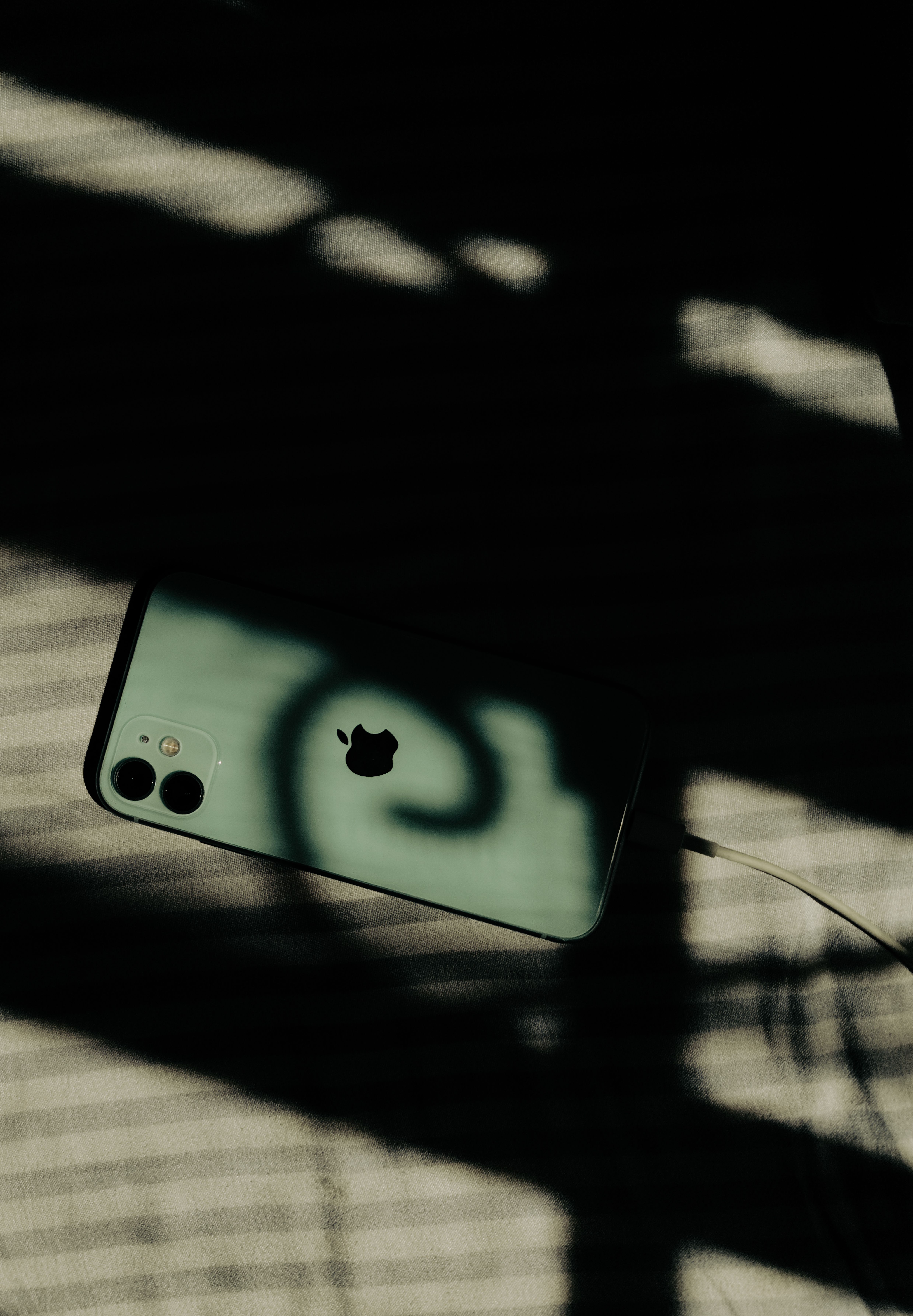 iPhone on Striped Surface in Dramatic Shadows · Free Stock Photo