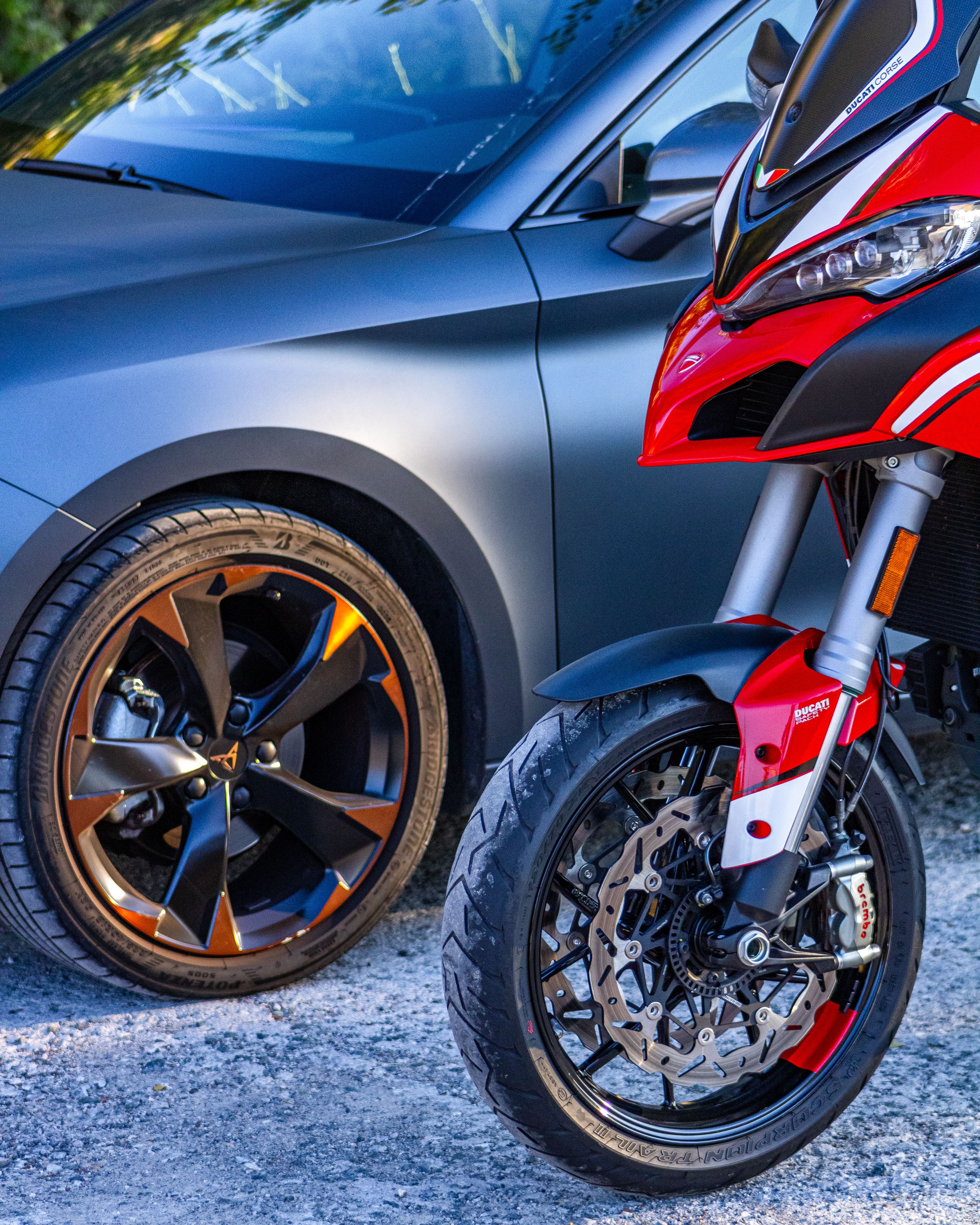 Red Motorcycle and Black Matte Car Outdoors · Free Stock Photo