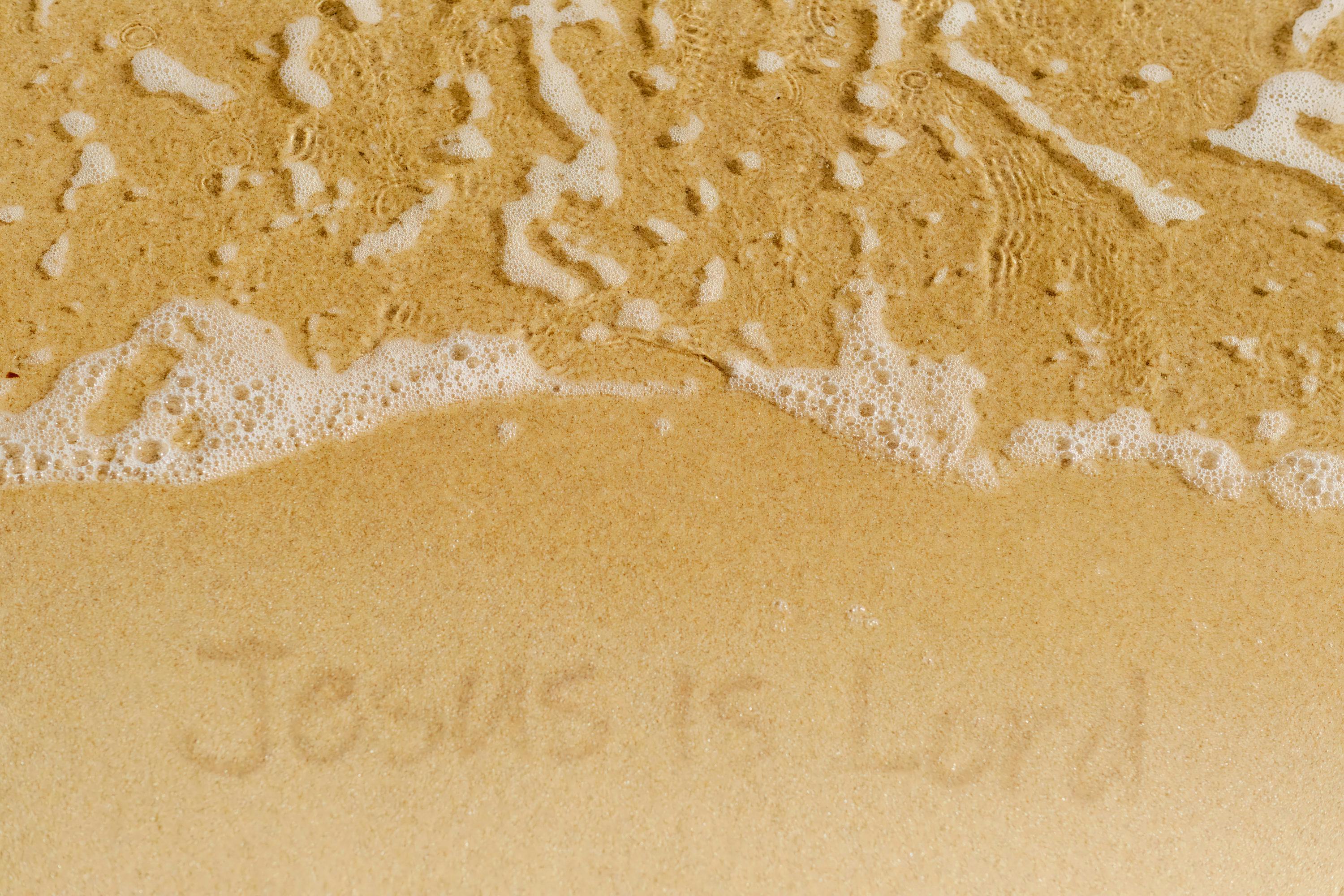 Inspiring Beach Message Pictured in Sand and Foam · Free Stock Photo