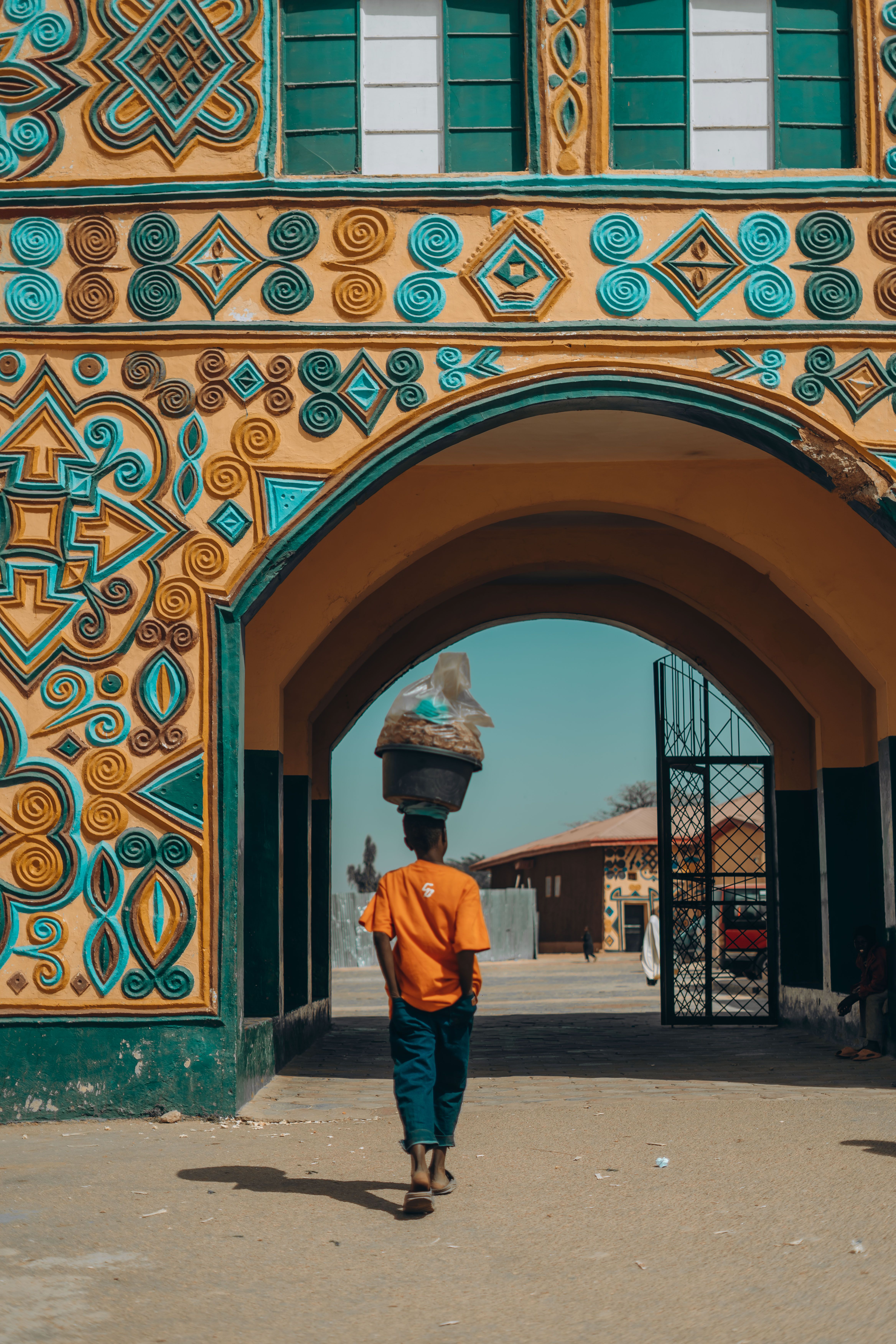Colorful Architecture with Person Walking Under Archway · Free Stock Photo