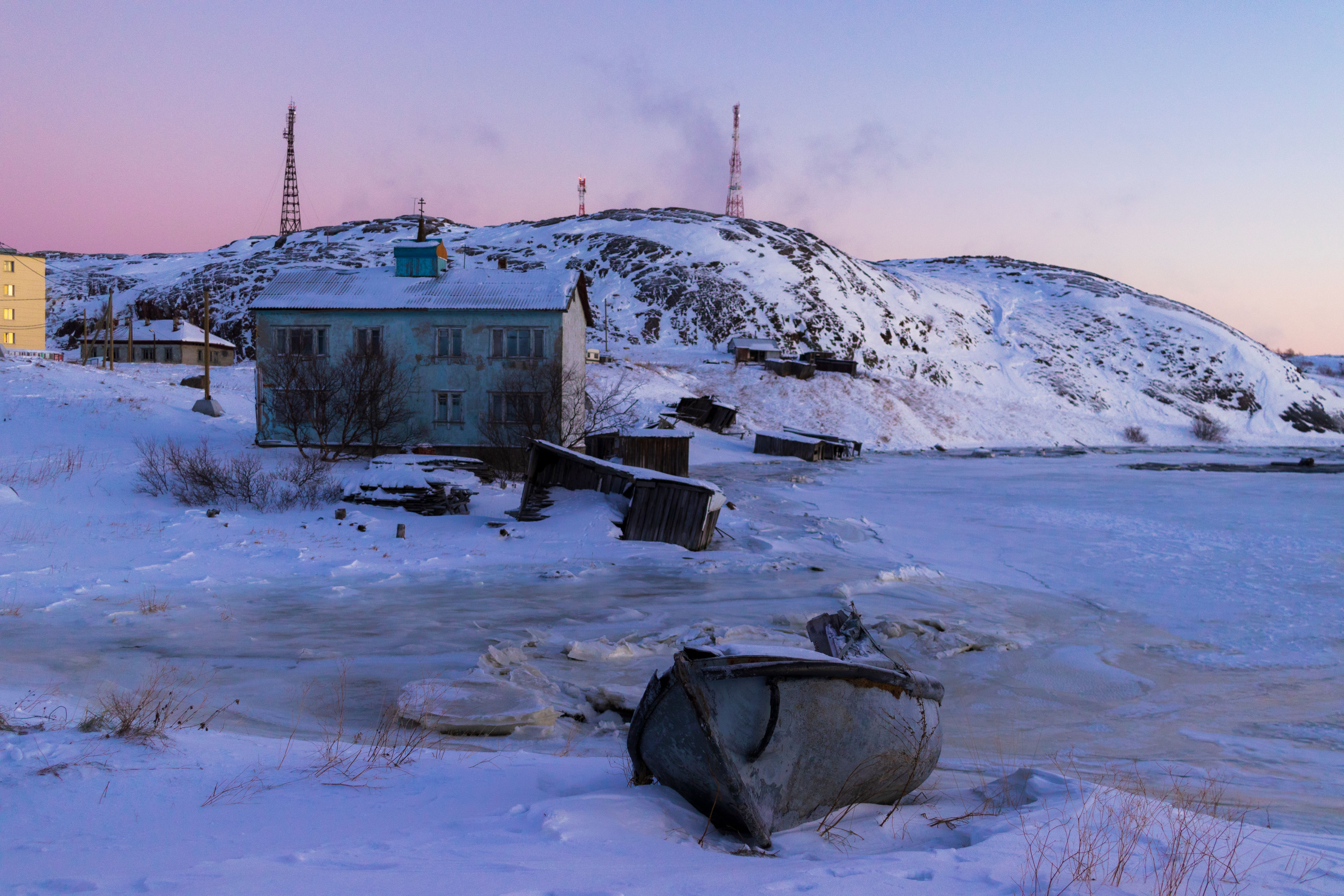 Frozen tundra with abandoned building at twilight · Free Stock Photo