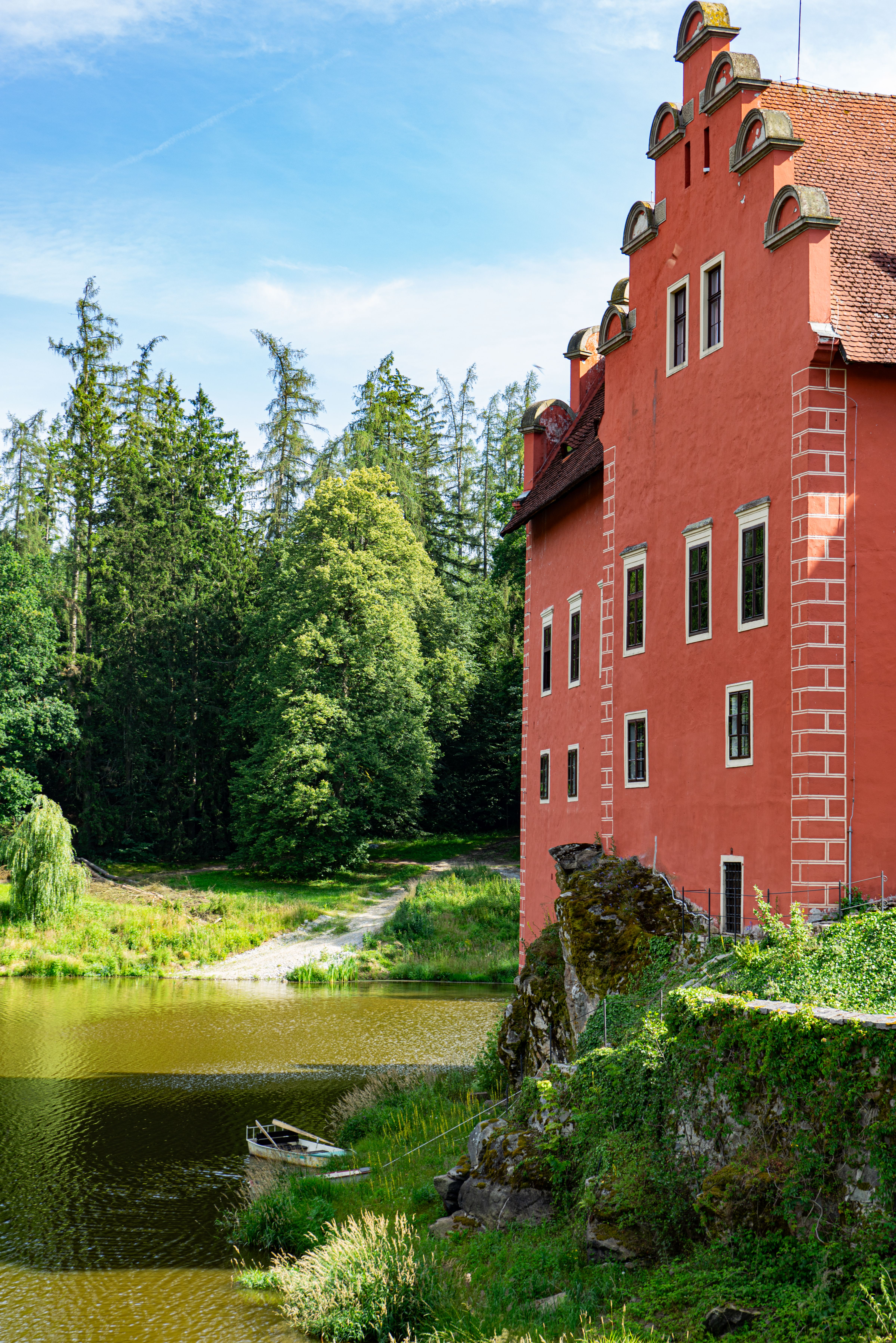 Charming Red Castle by Lakeside in Jihočeský · Free Stock Photo