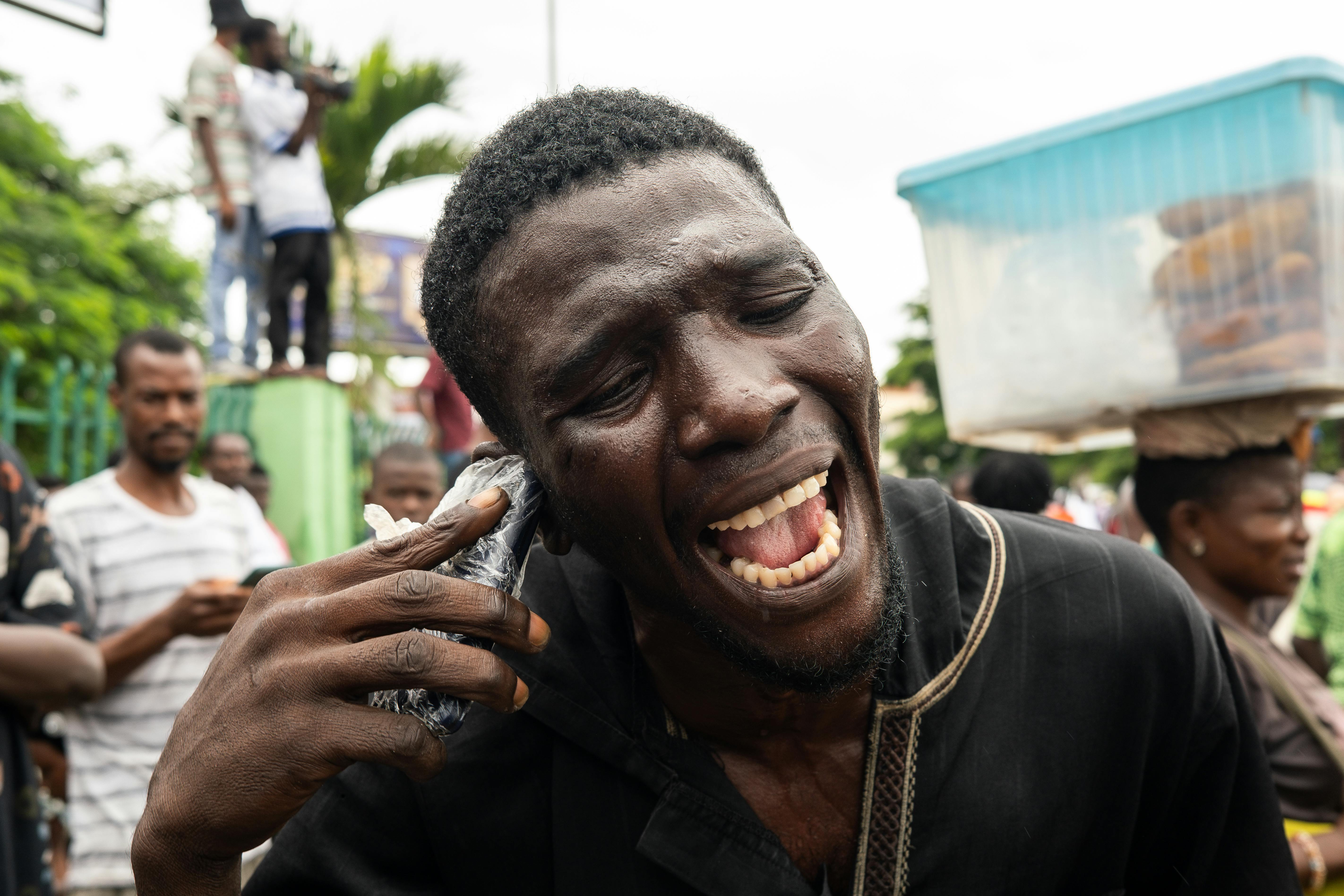 Expressive Street Scene of Singing Man at Protest · Free Stock Photo