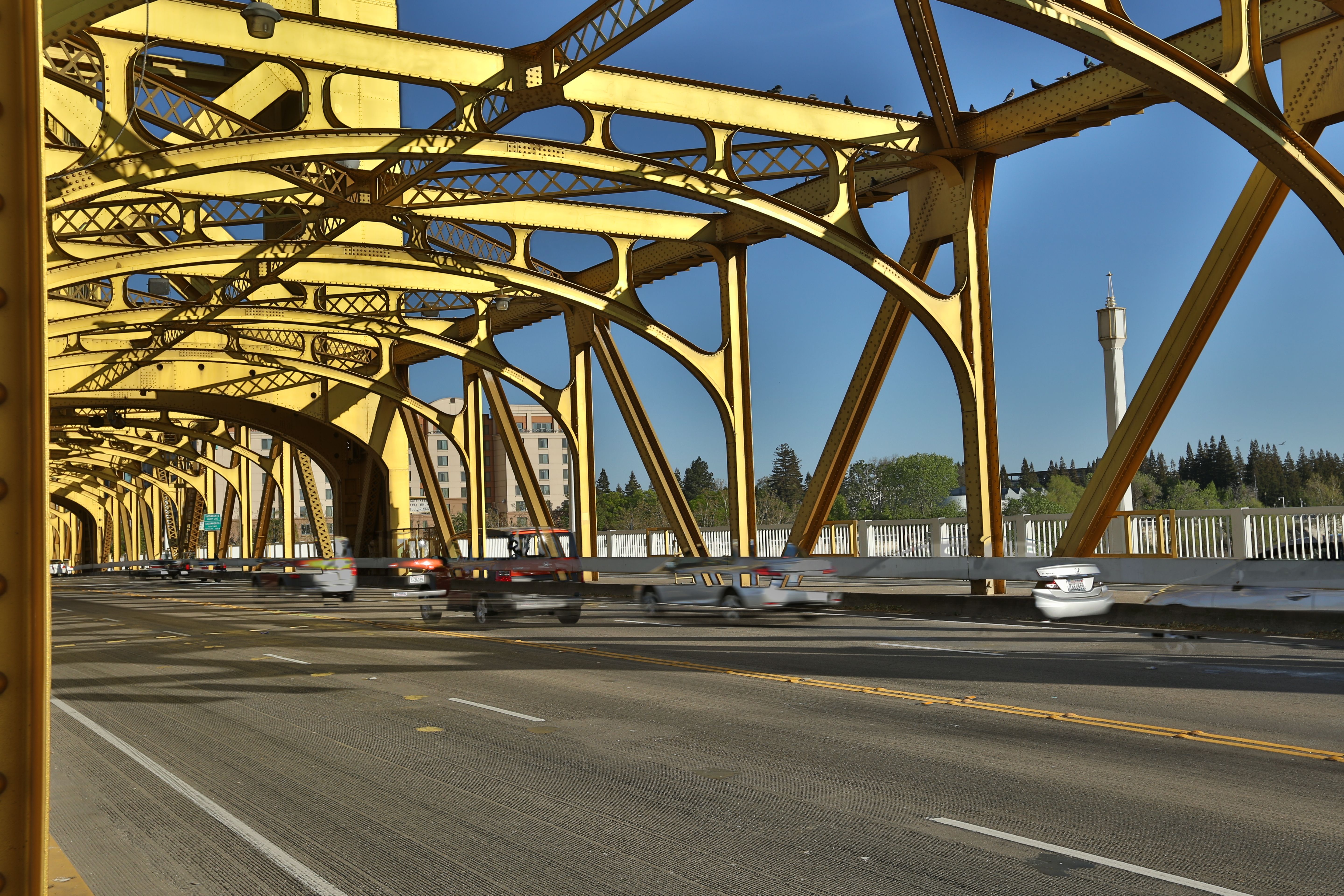 Iconic Yellow Bridge with Tower in Background · Free Stock Photo