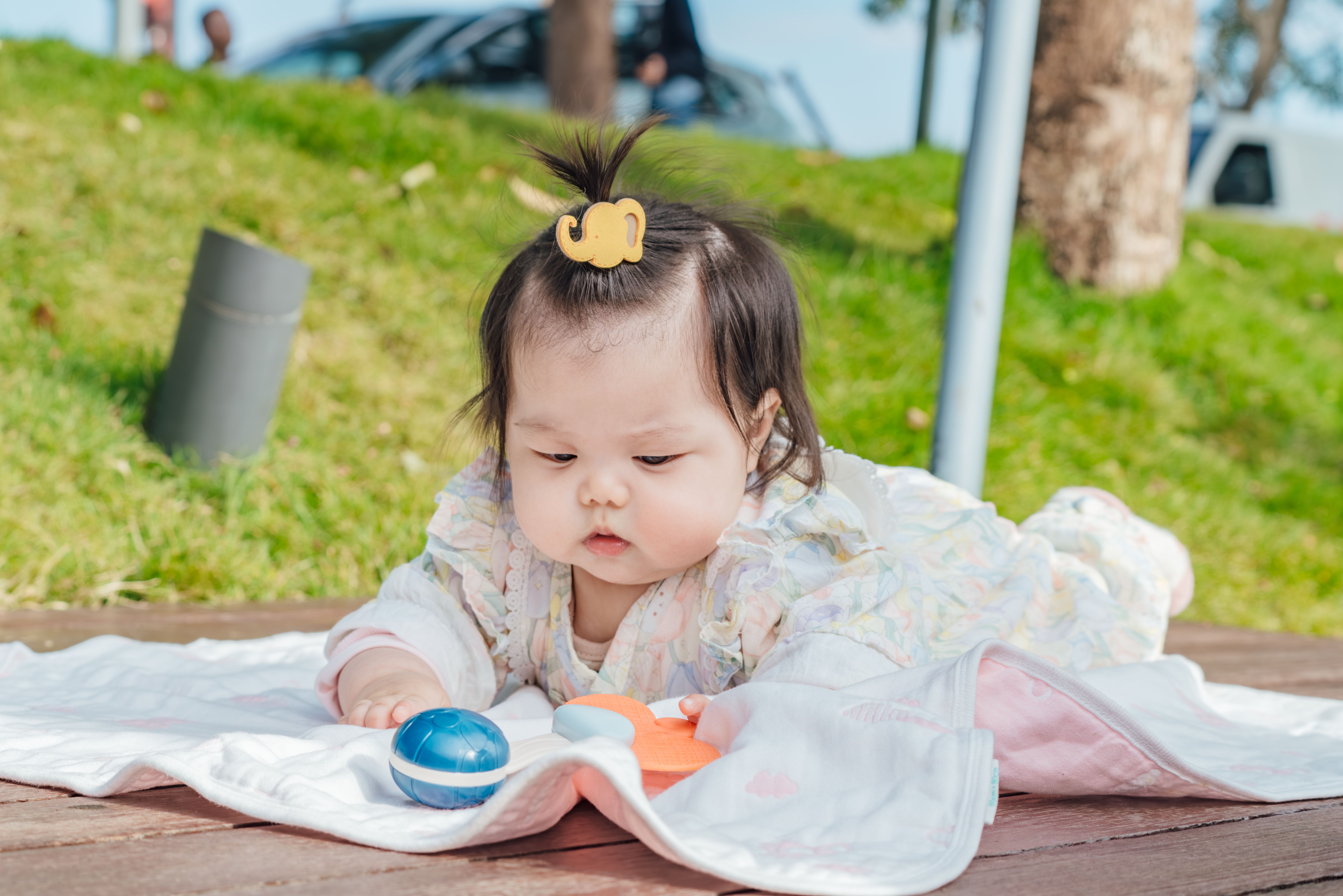 Adorable Baby Playing Outdoors with Toys · Free Stock Photo