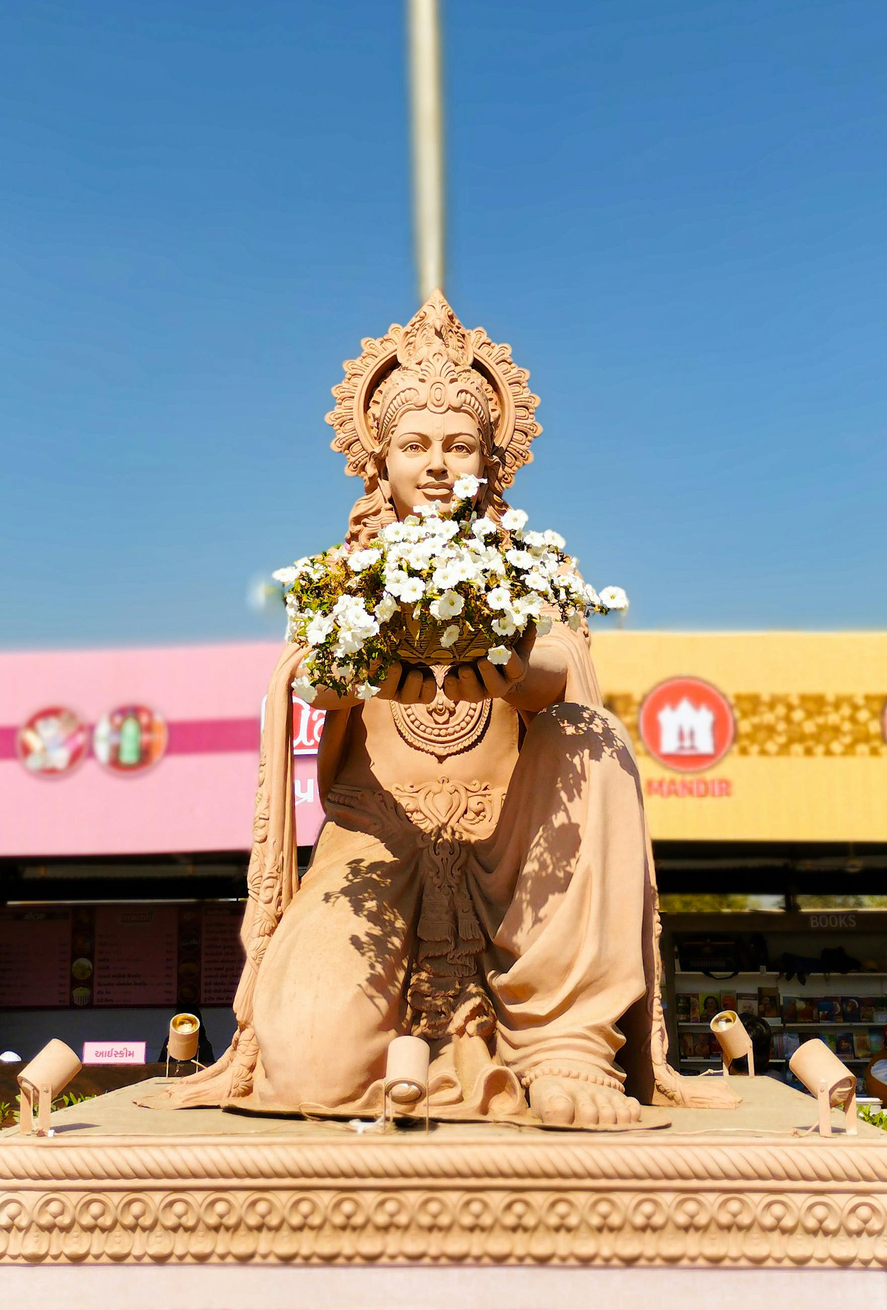 Intricate Statue with Floral Offering in Ahmedabad · Free Stock Photo